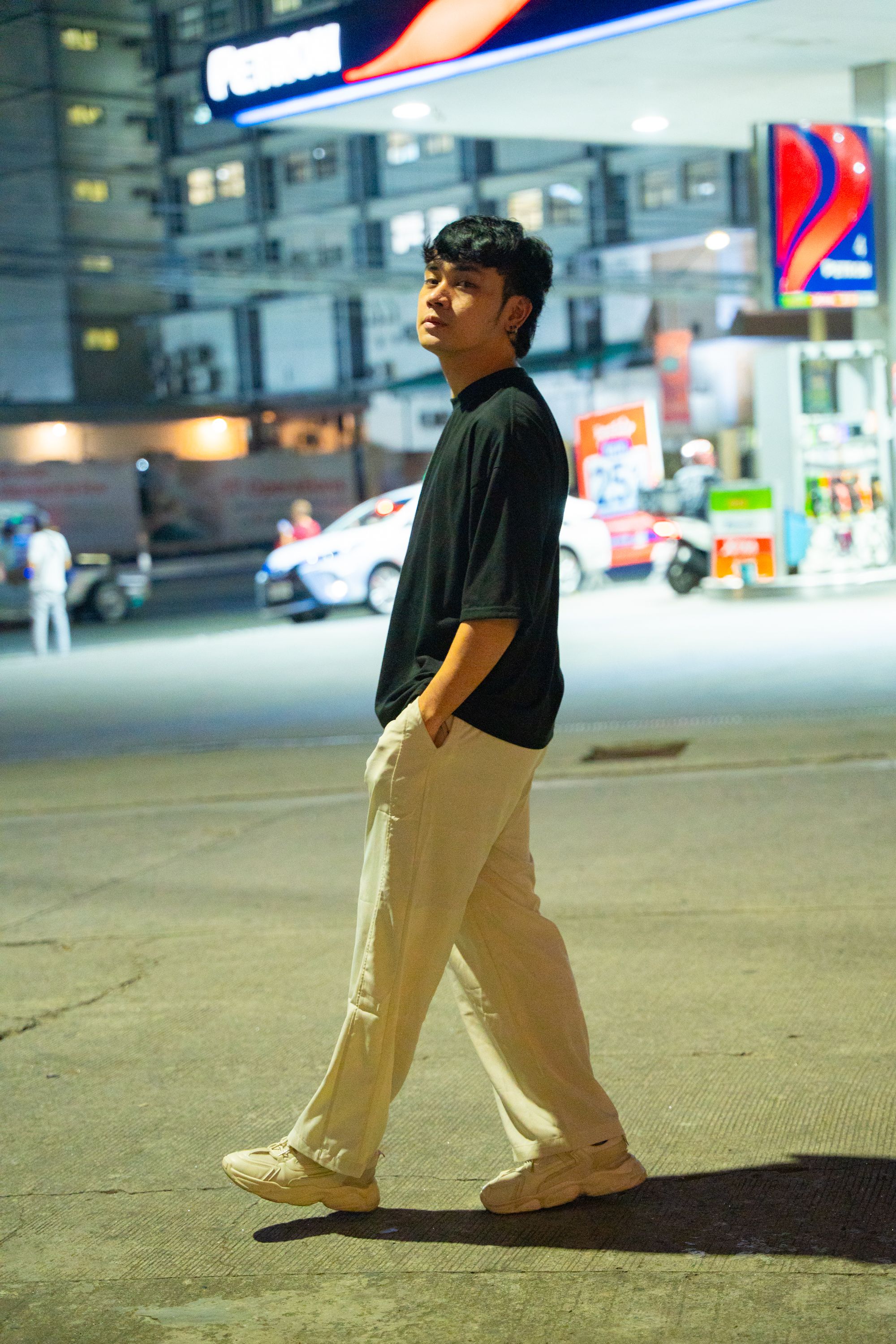 Young Man Walking at Night in Urban Setting · Free Stock Photo