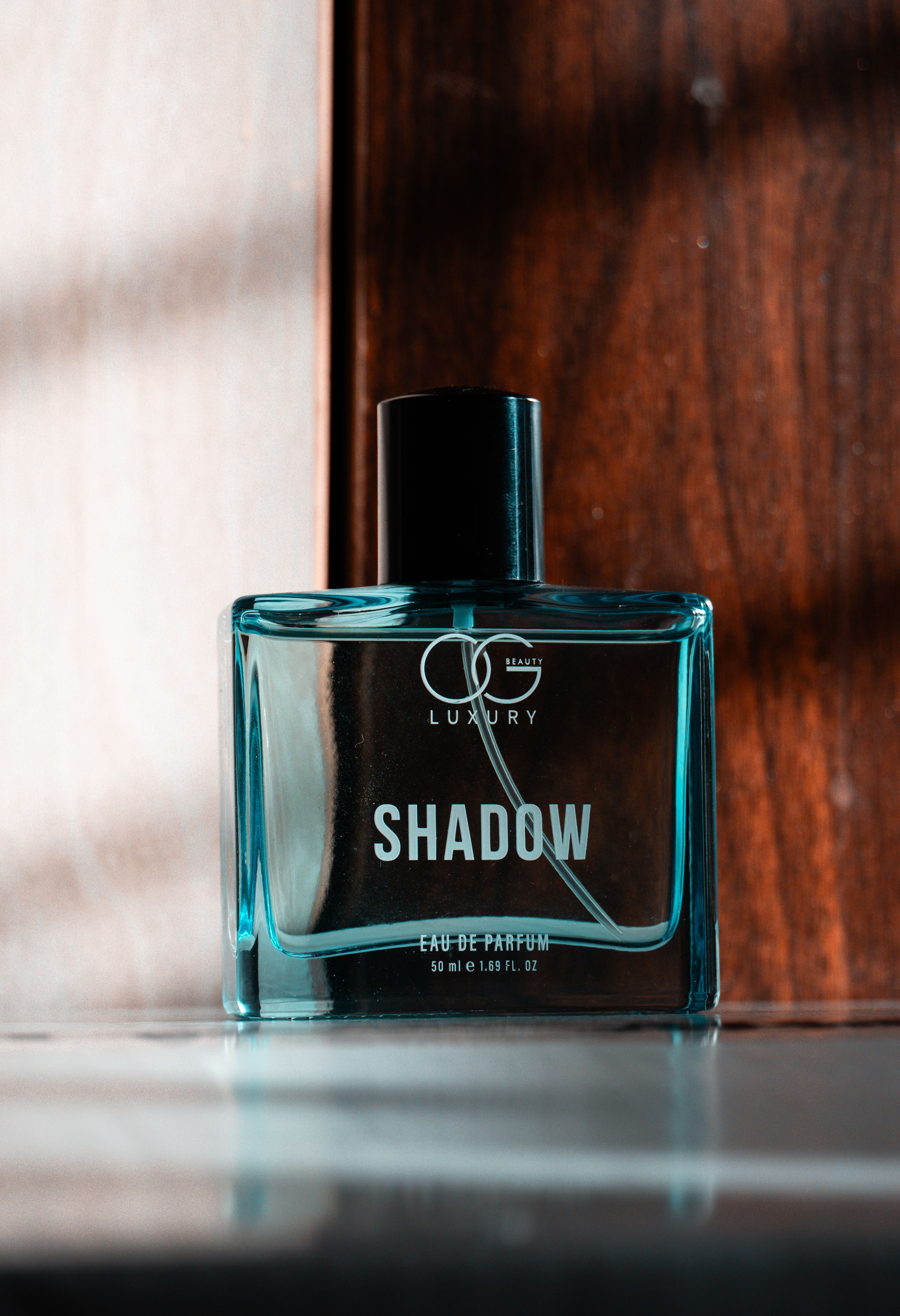 Elegant Shadow Perfume Bottle in Natural Light · Free Stock Photo