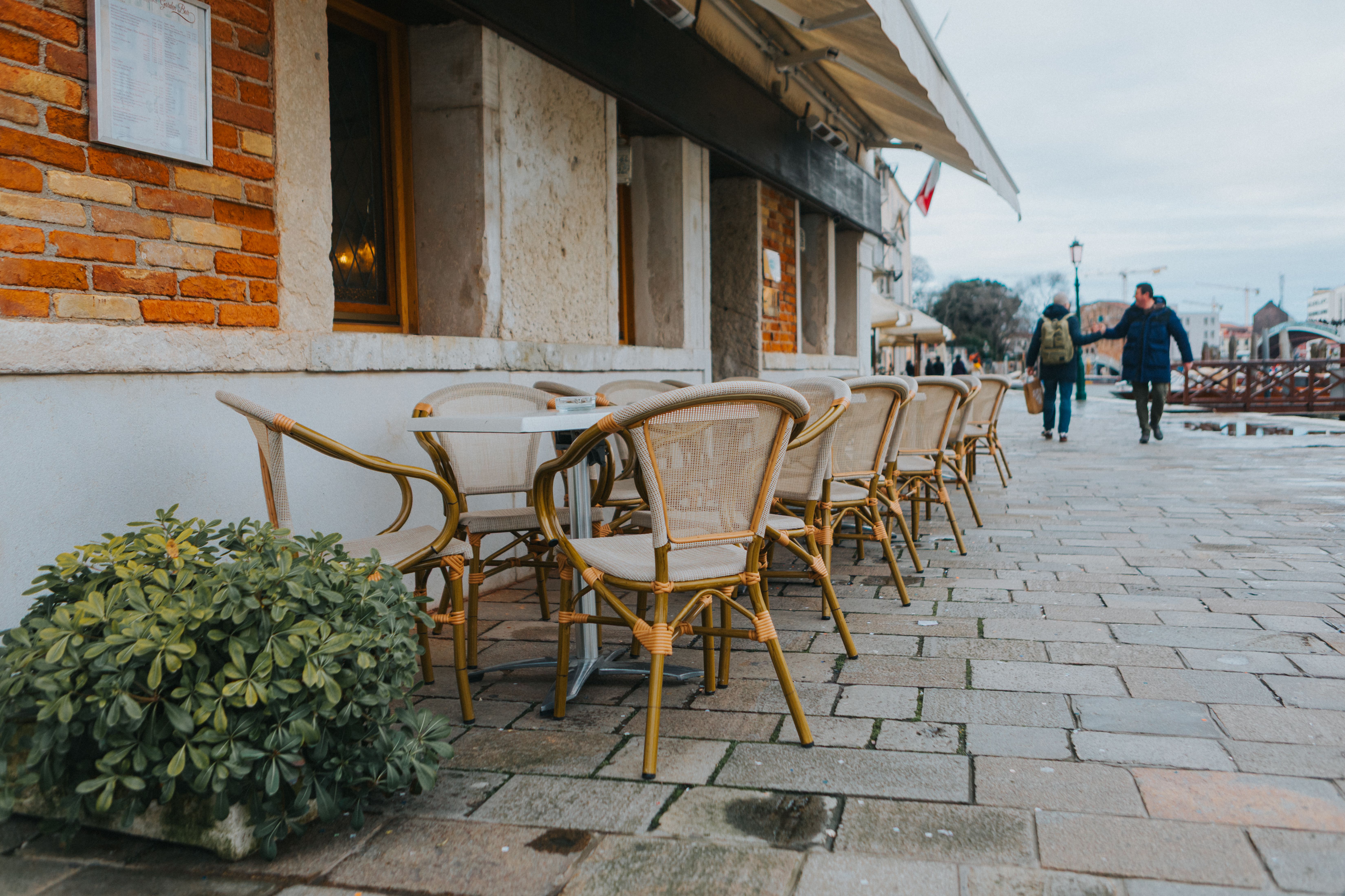 Charming European Outdoor Café on Cobblestone Street · Free Stock Photo