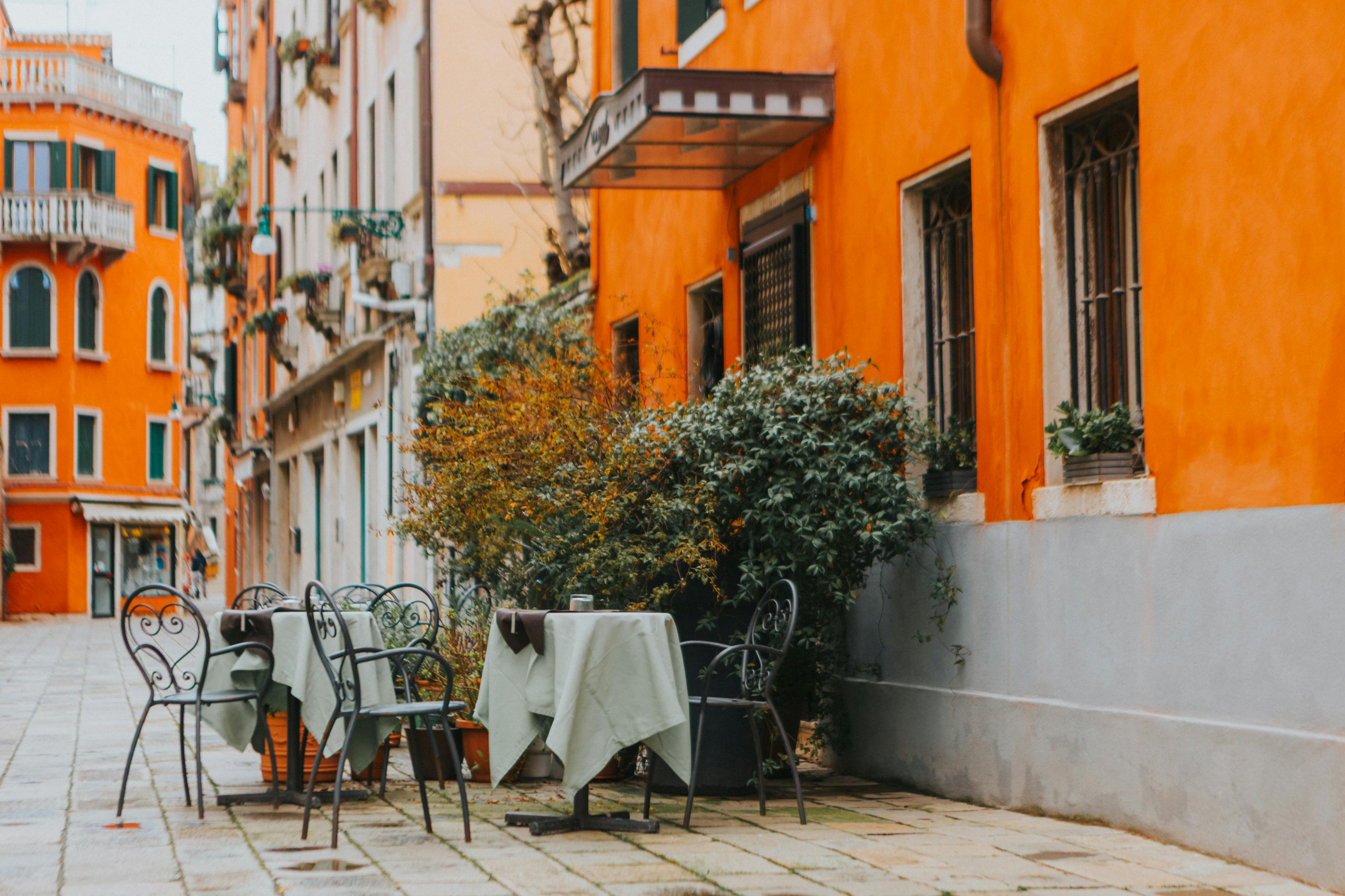 Charming Outdoor Cafe Setting in European Alleyway · Free Stock Photo