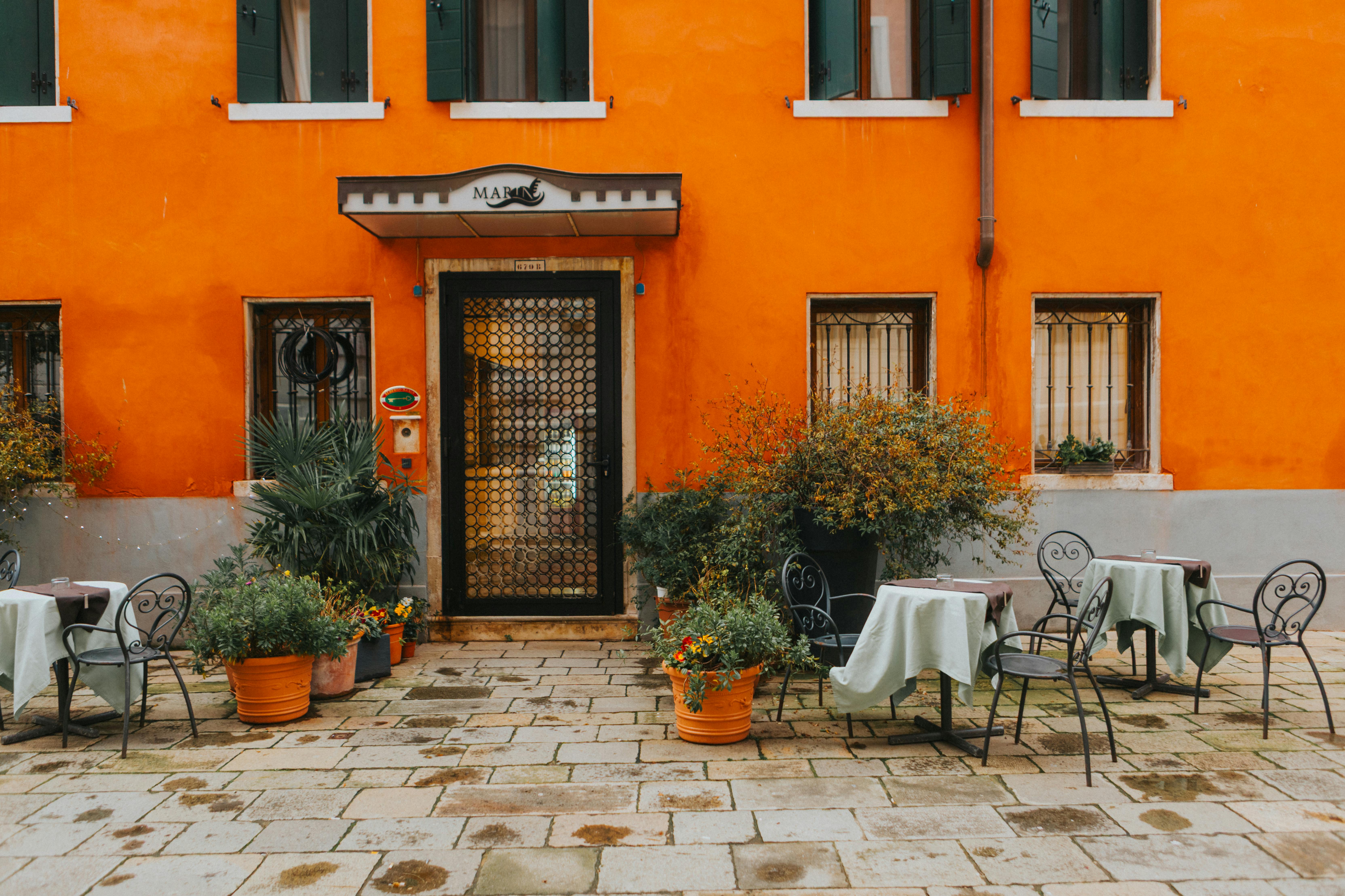 Charming Outdoor Cafe Setting in Vibrant Orange · Free Stock Photo