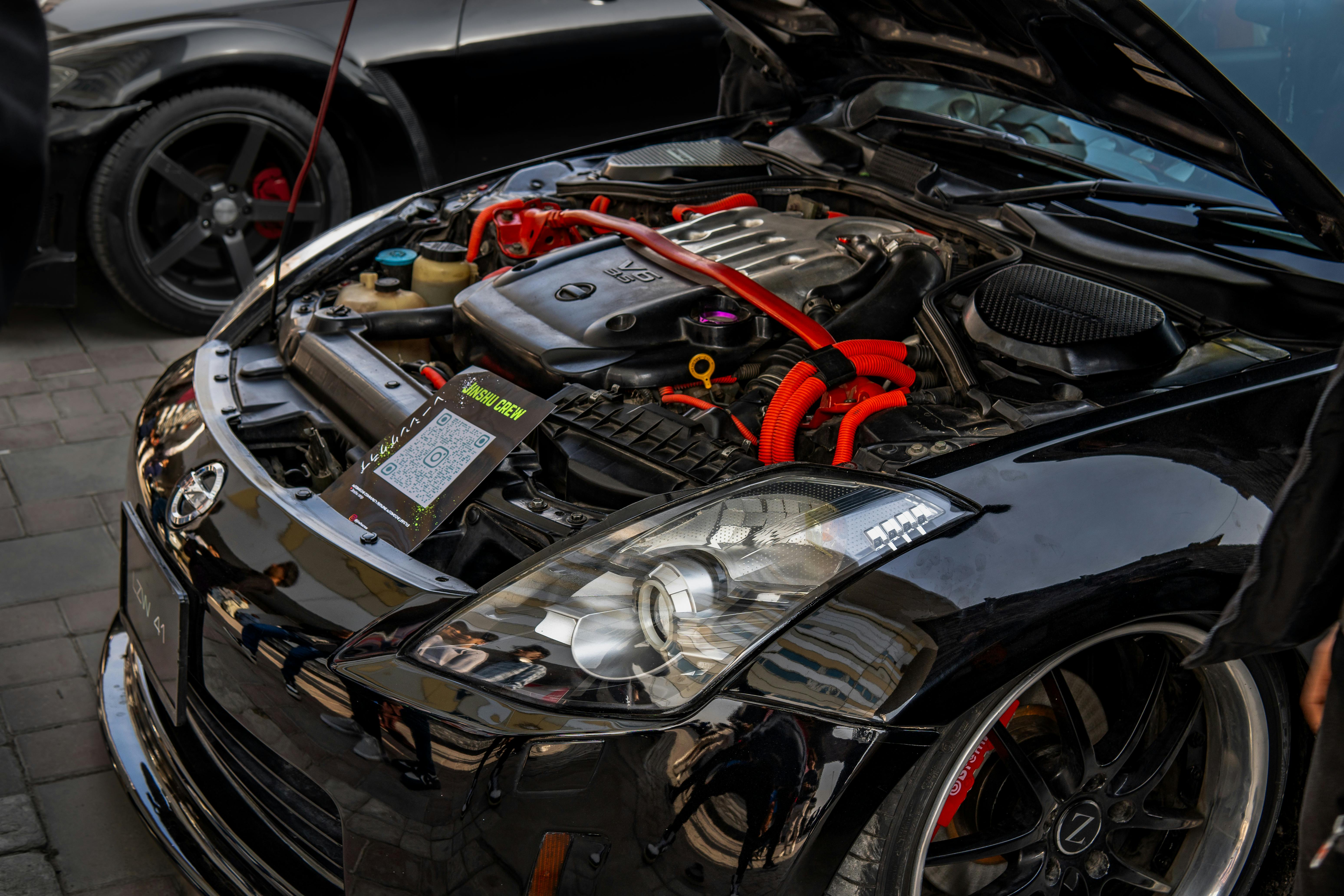 High-performance car engine showcased outdoors · Free Stock Photo