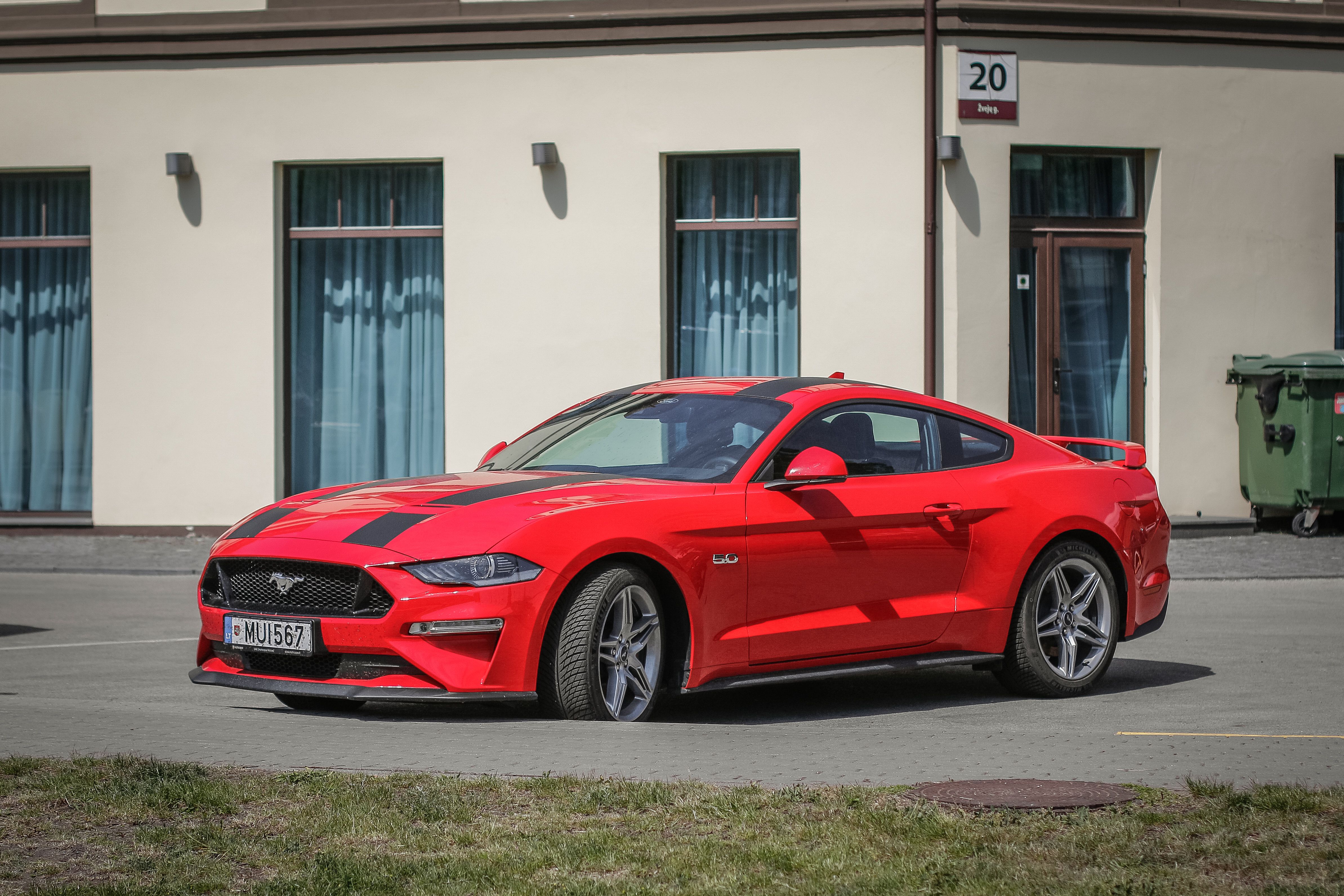 Red Sports Car Parked in Urban Setting · Free Stock Photo