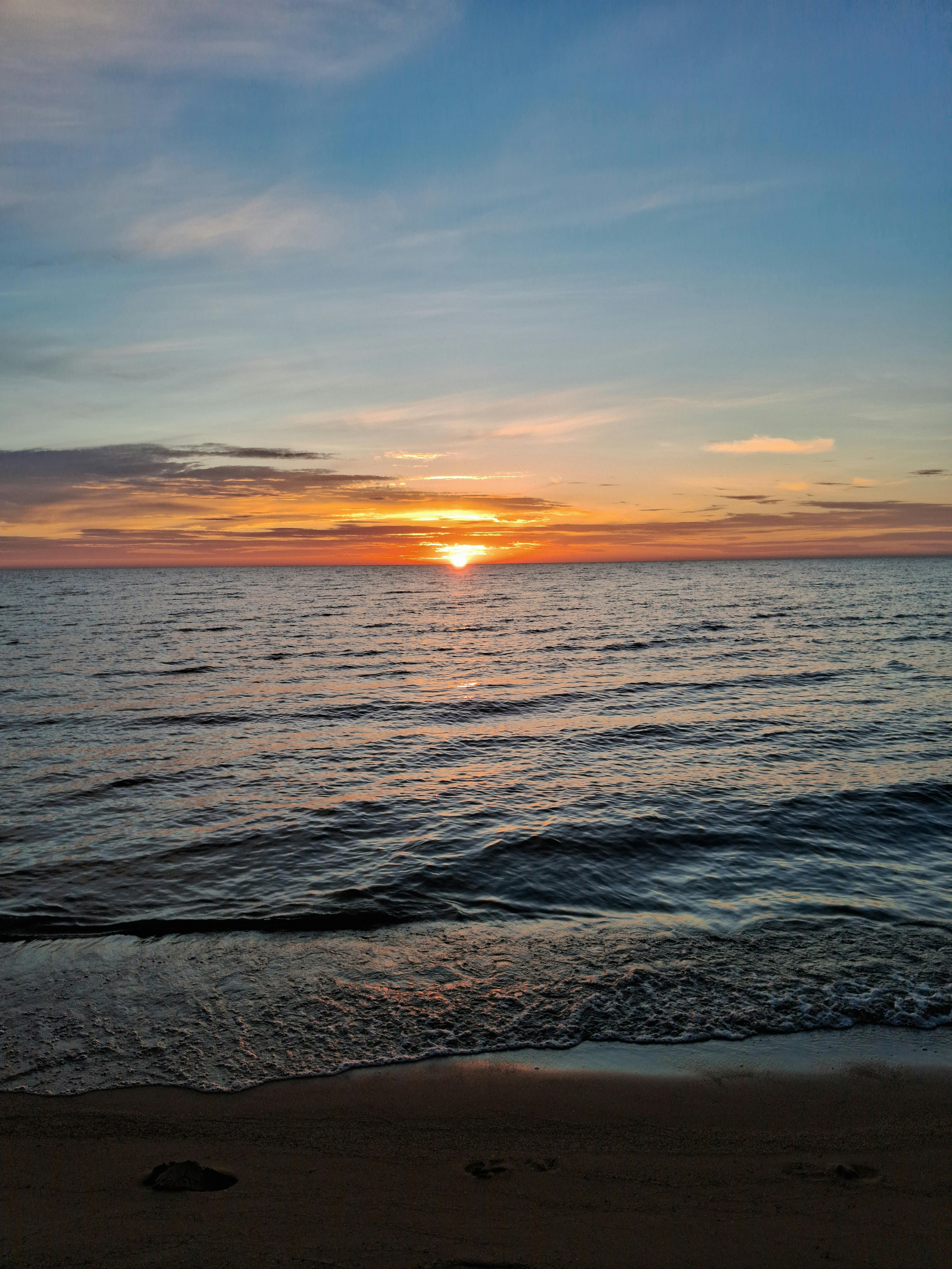 Tranquil Sunset Over Open Sea Horizon · Free Stock Photo