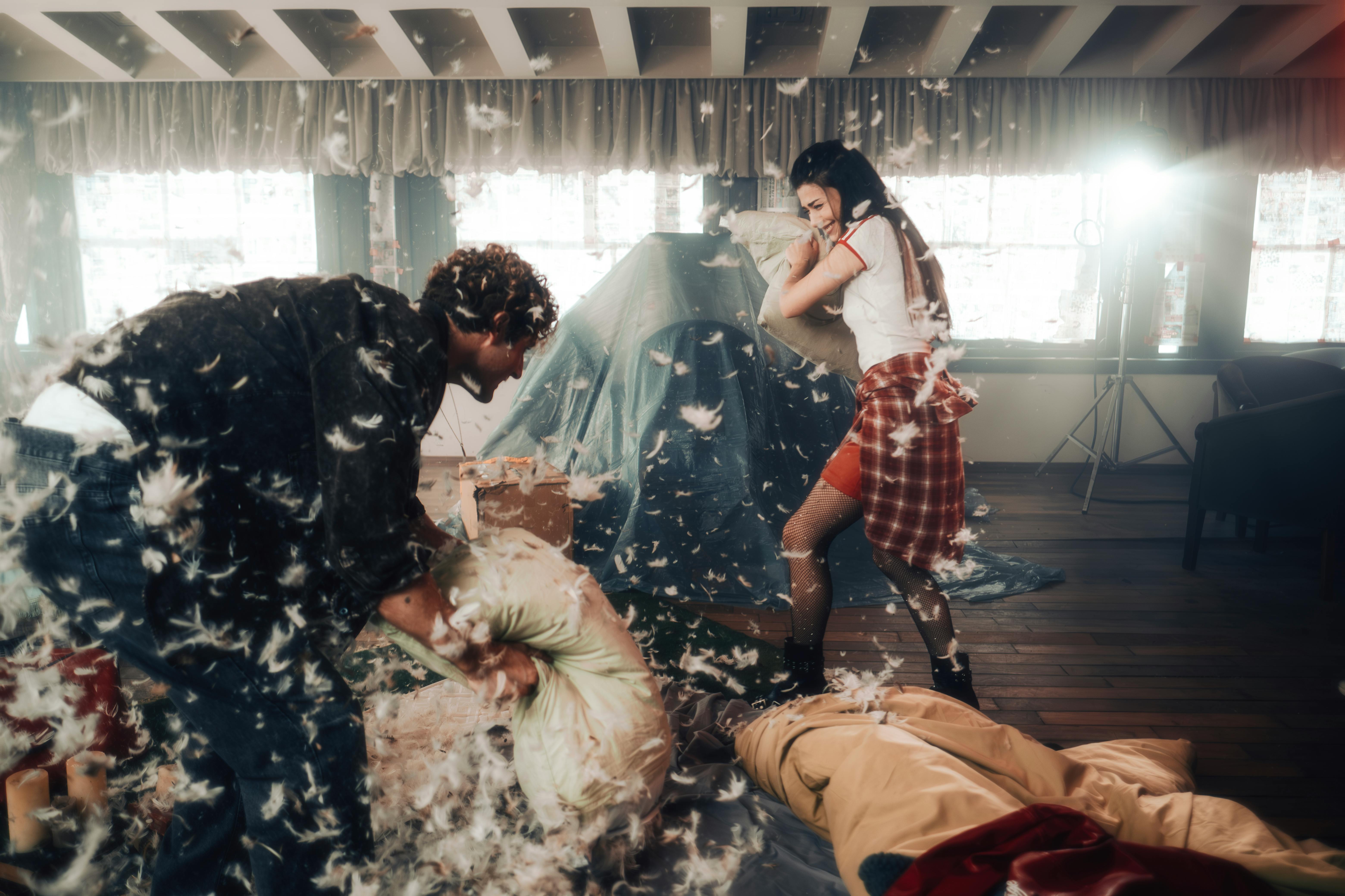 Fun Indoor Pillow Fight with Feathers · Free Stock Photo