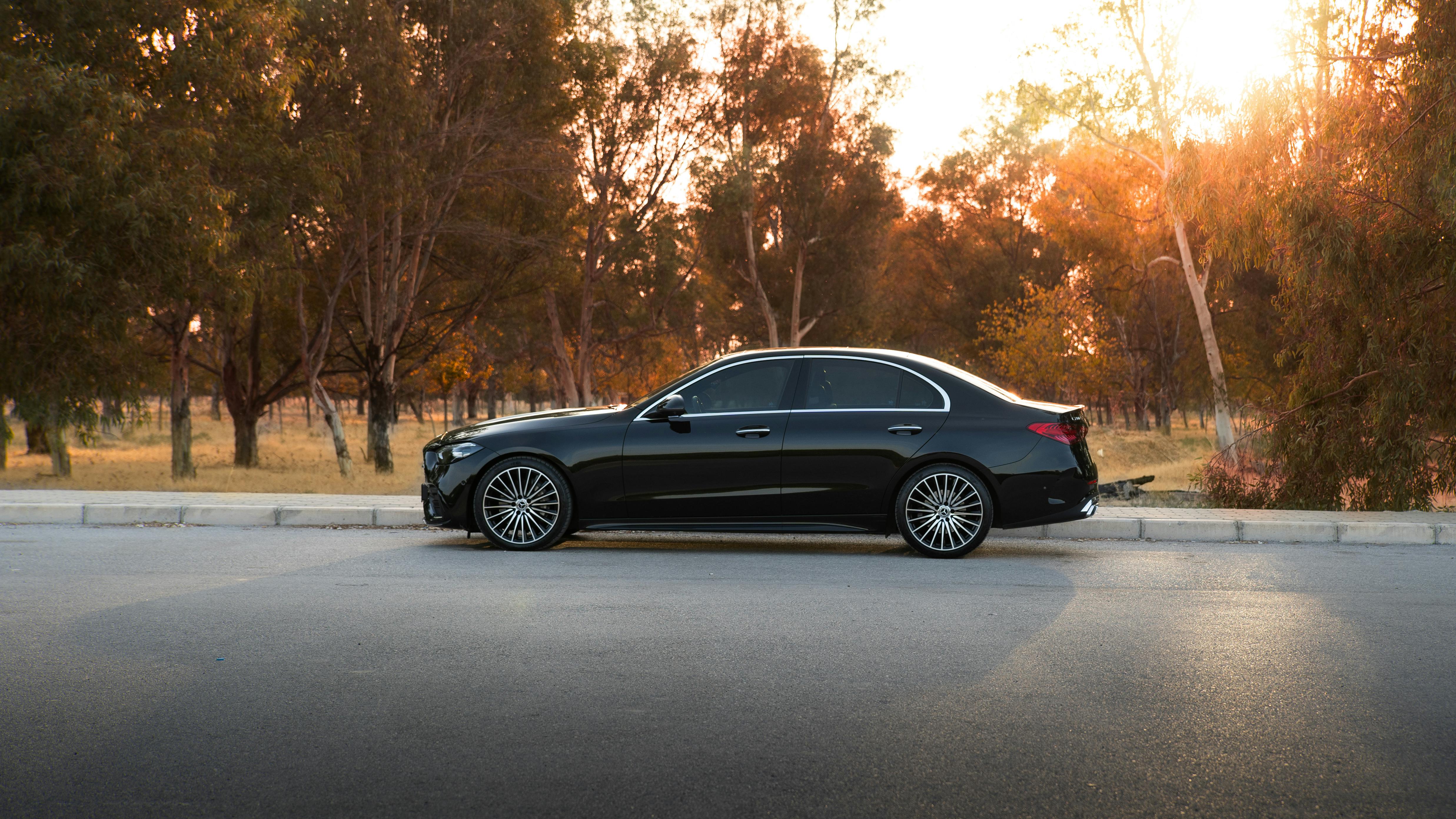 Elegant Black Car Parked on Sunset Street in Izmir · Free Stock Photo