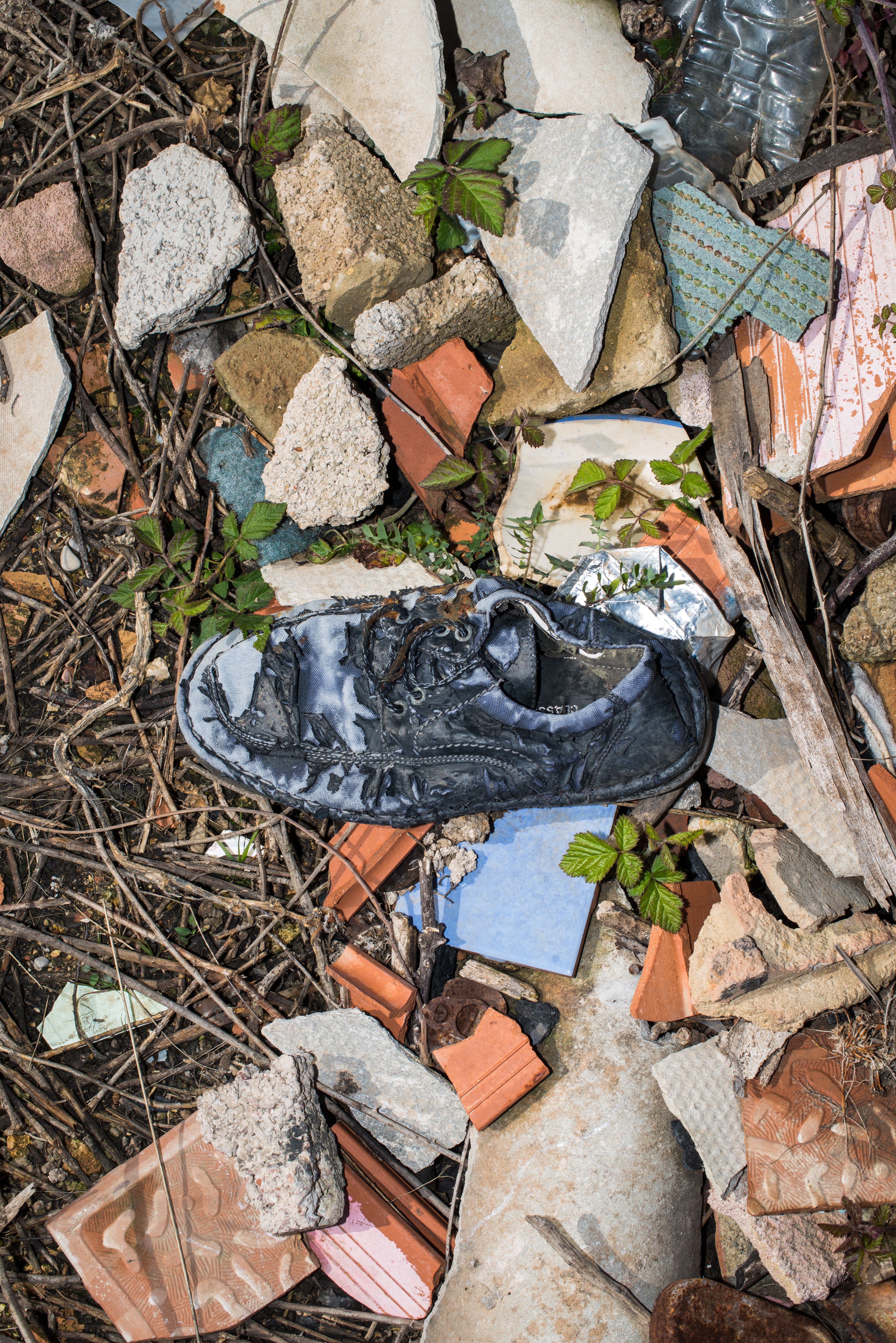Discarded Shoe Among Urban Debris Outdoors · Free Stock Photo