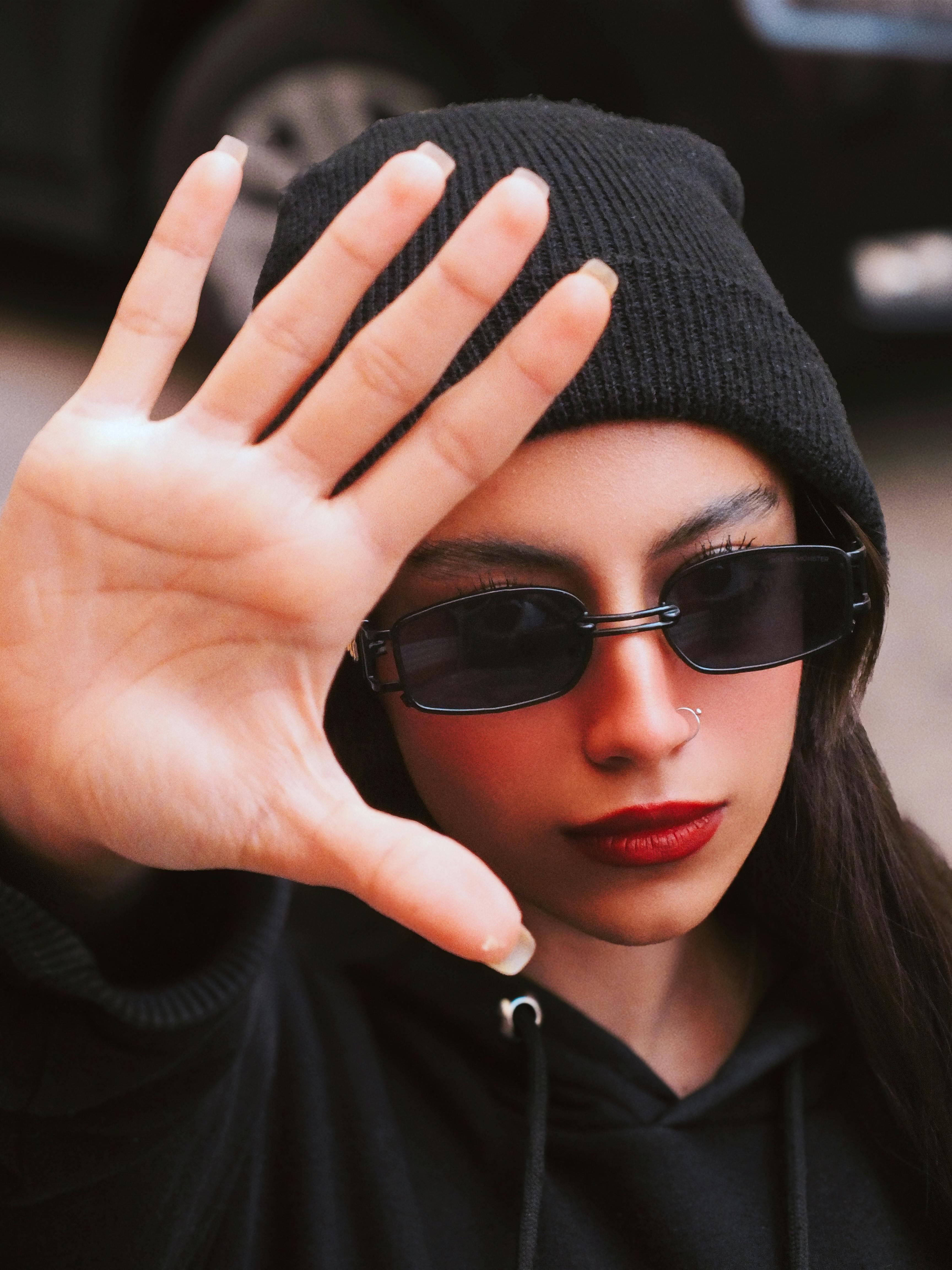 Young Woman in Fashionable Streetwear Blocking Camera · Free Stock Photo