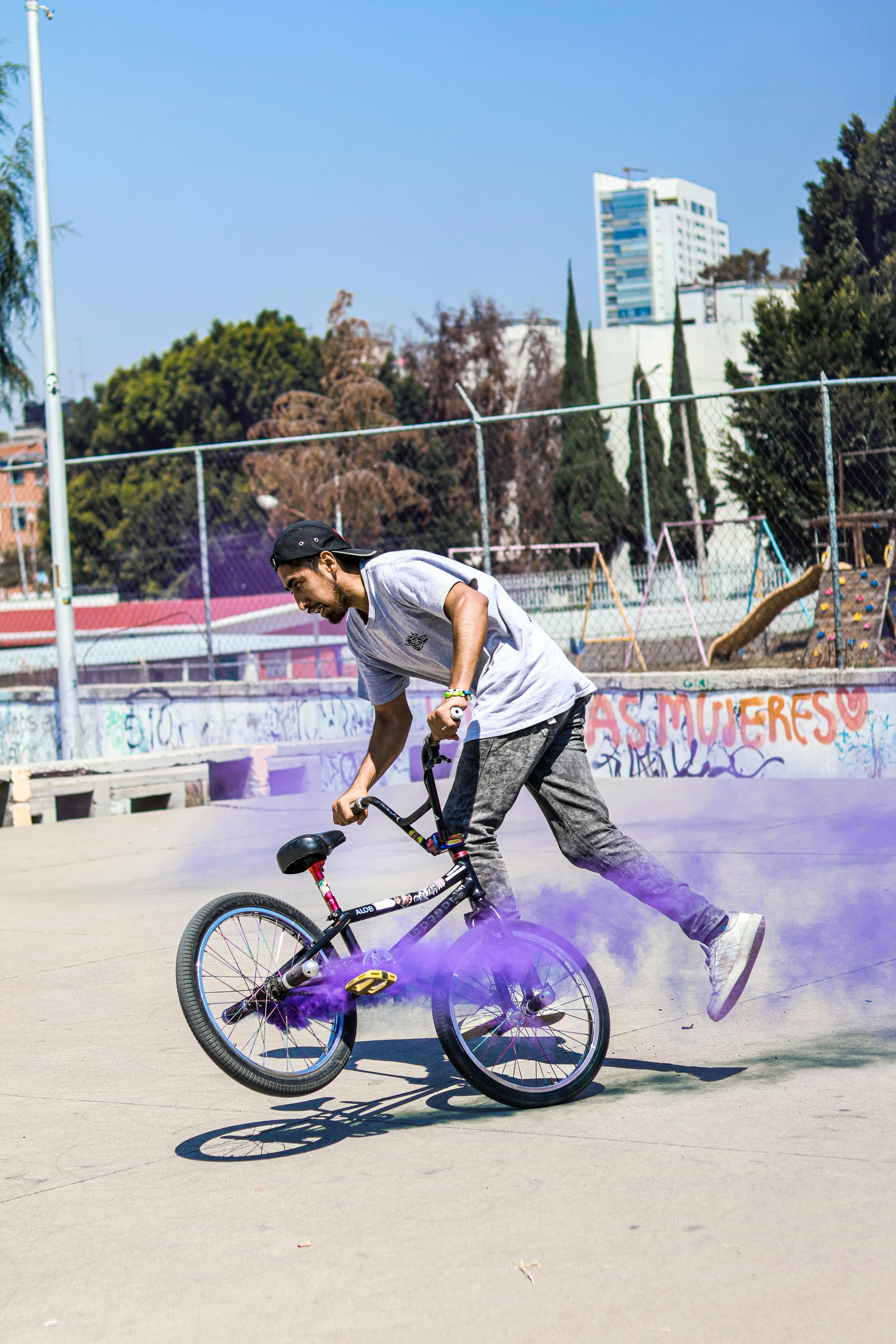 Dynamic BMX Stunt with Colorful Smoke in Skate Park · Free Stock Photo