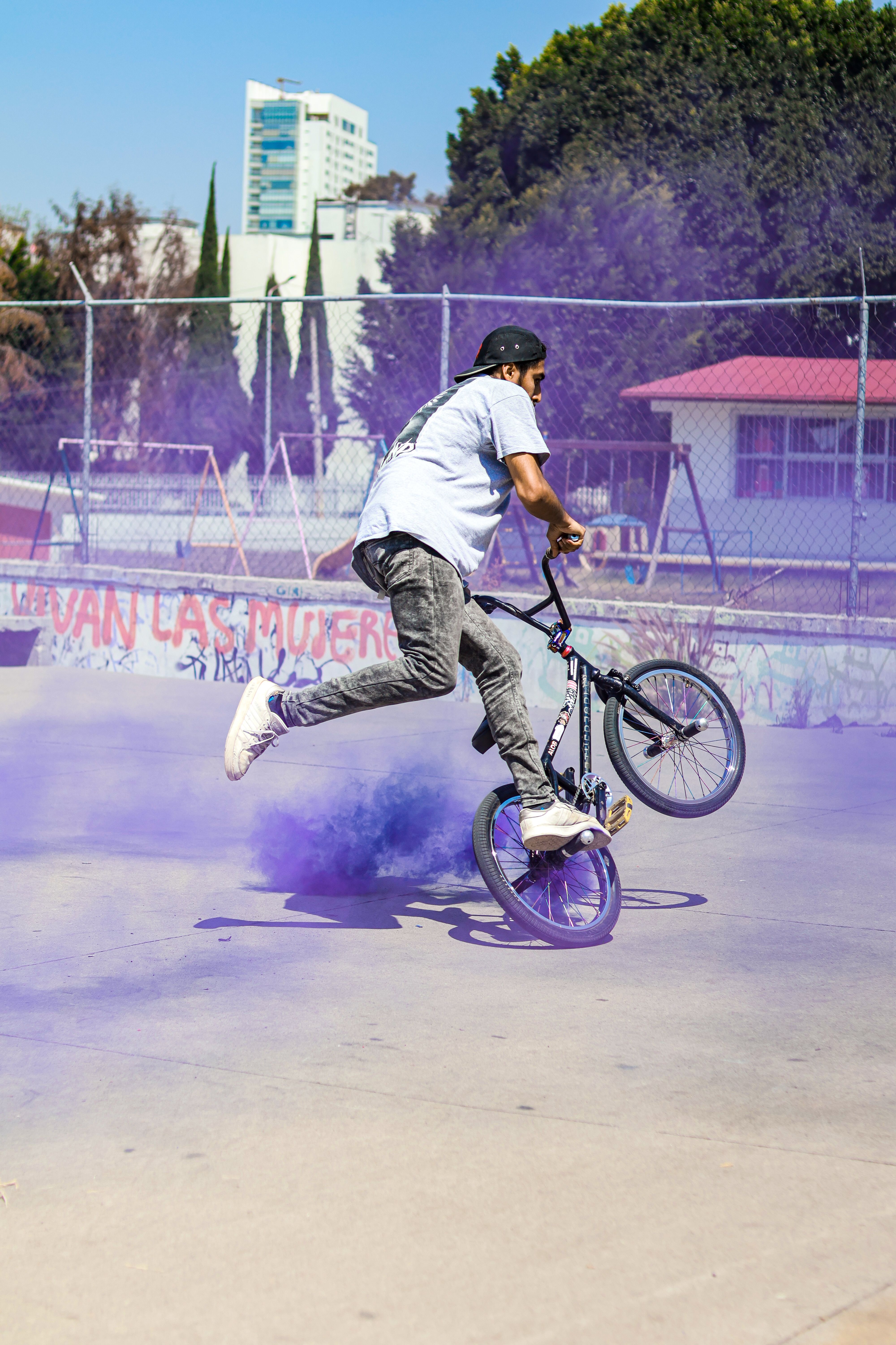 Dynamic BMX Trick with Purple Smoke at Skate Park · Free Stock Photo