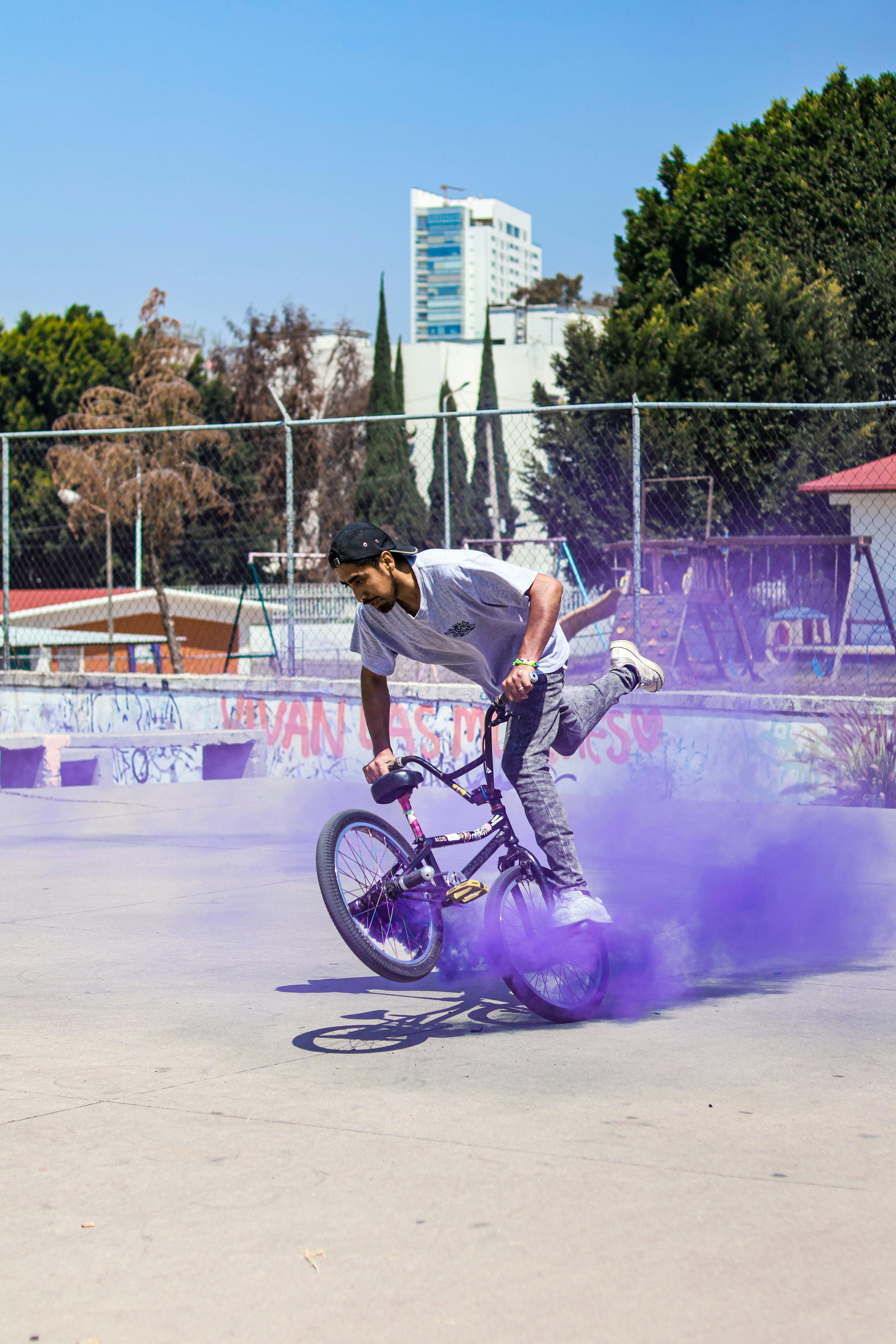 BMX Stunt Rider with Purple Smoke at Skatepark · Free Stock Photo