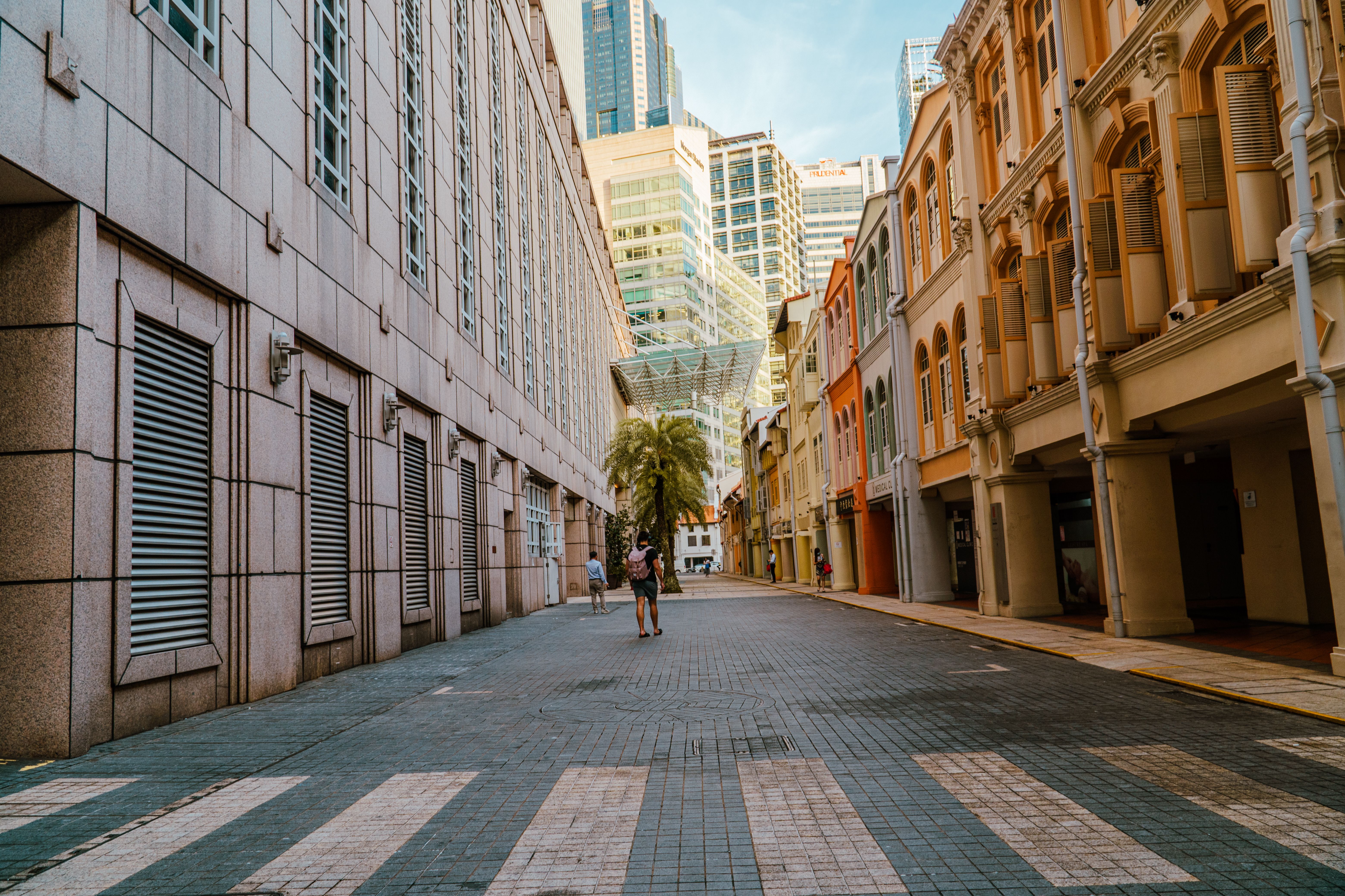 Gray Asphalt Street in Between Yellow and White Concrete Buildings at ...