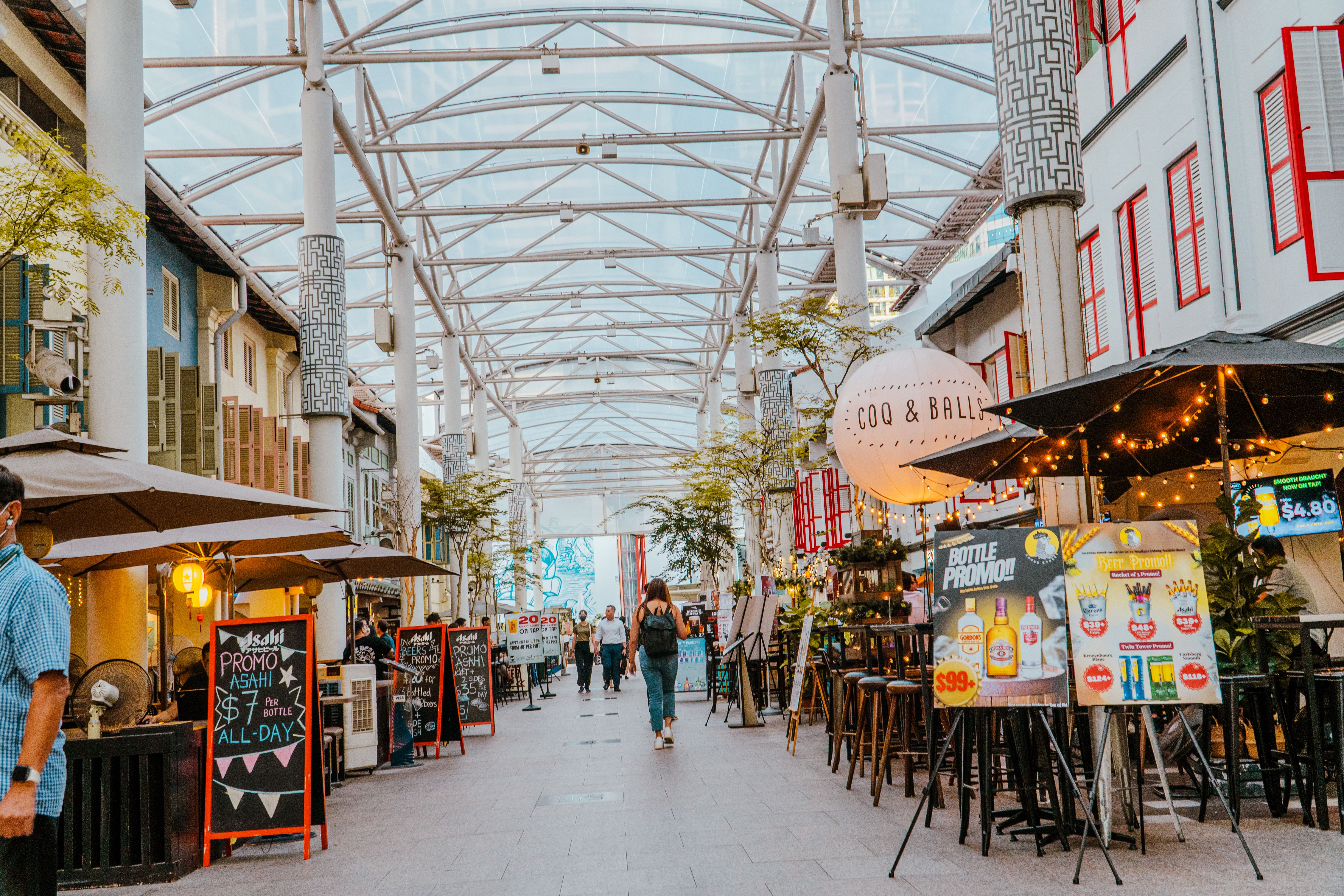 Vibrant Outdoor Shopping Arcade with Cafes · Free Stock Photo