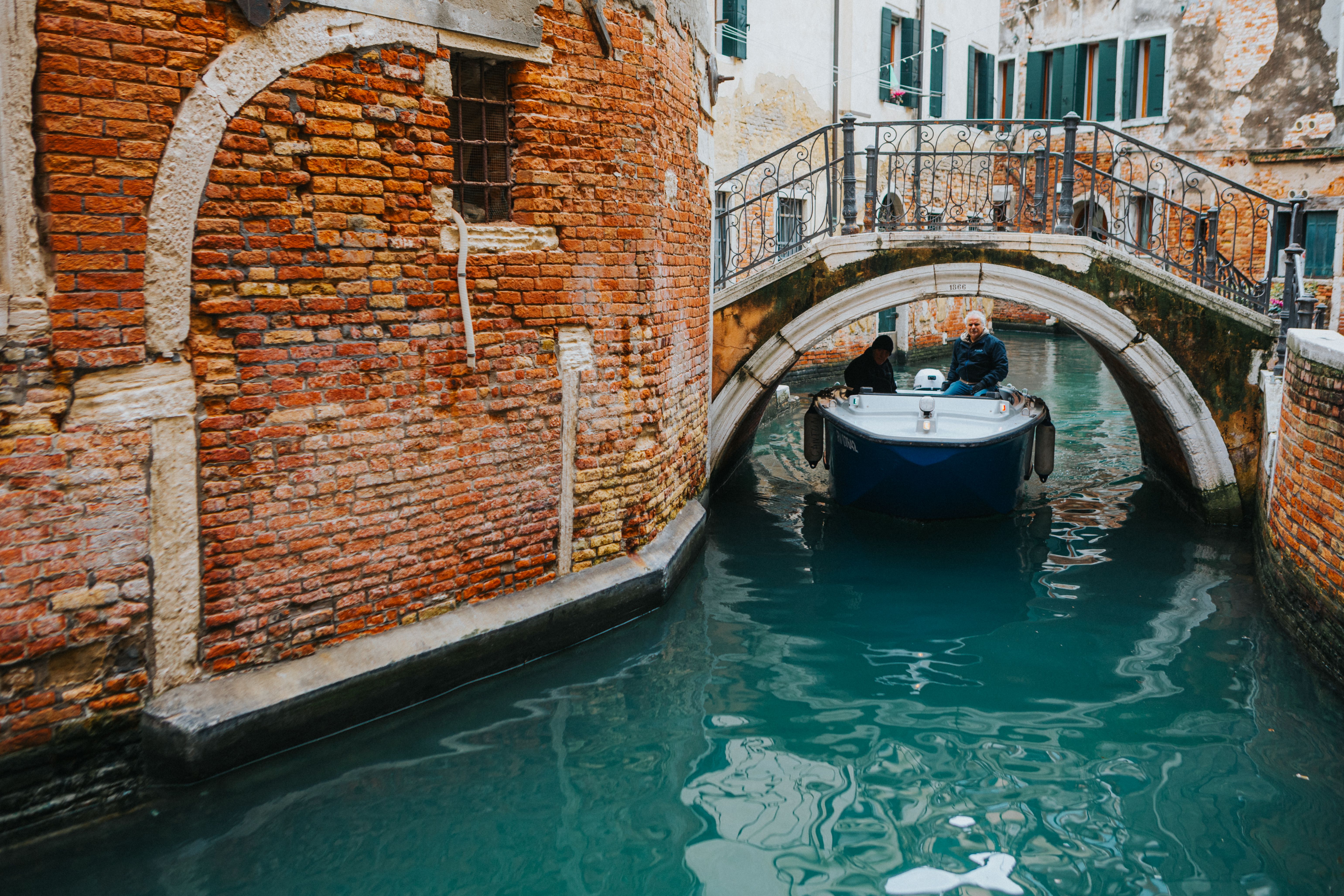 Scenic Venice Canal with Boat Under Bridge · Free Stock Photo