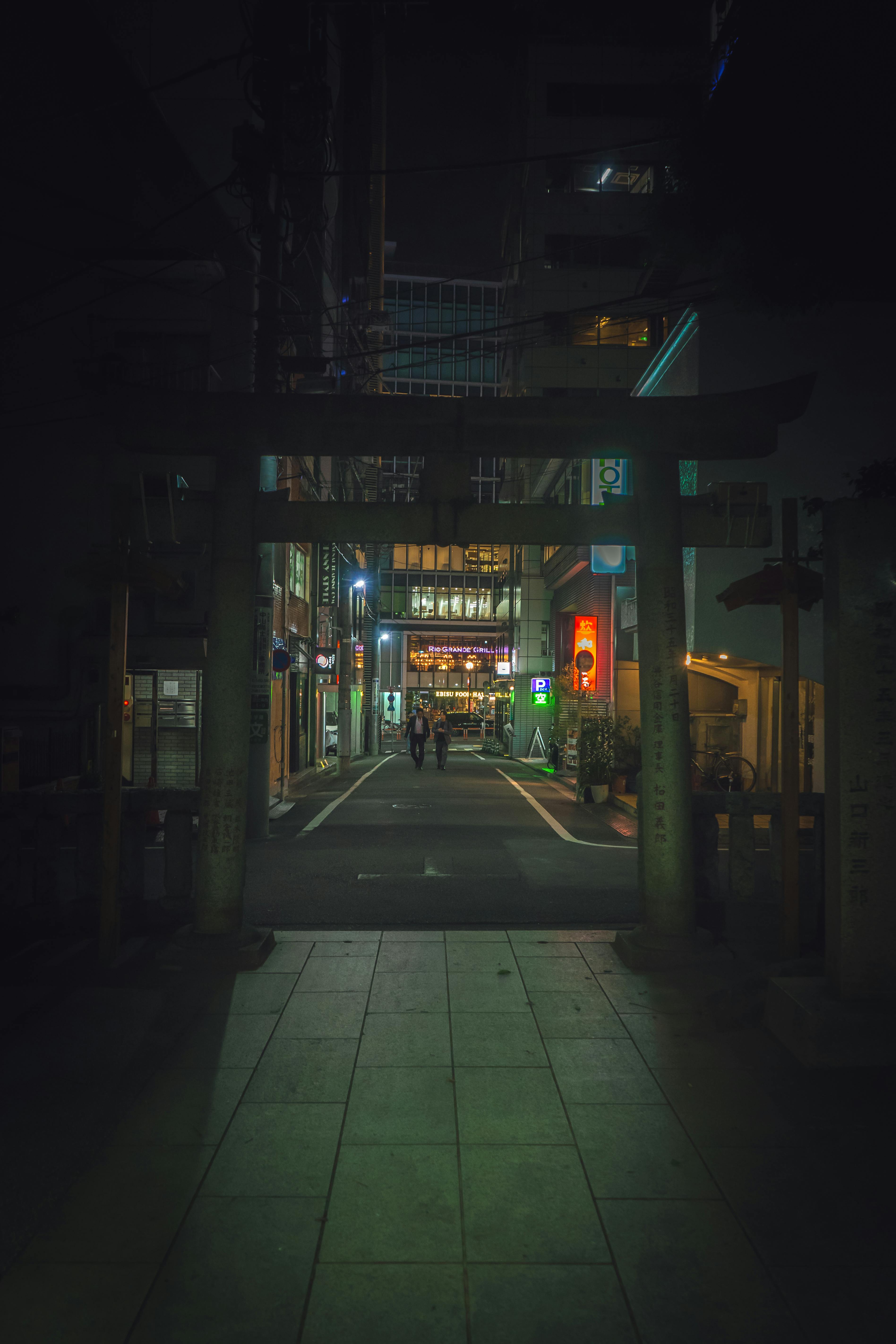 Night Scene Through Torii Gate in Urban Japan · Free Stock Photo