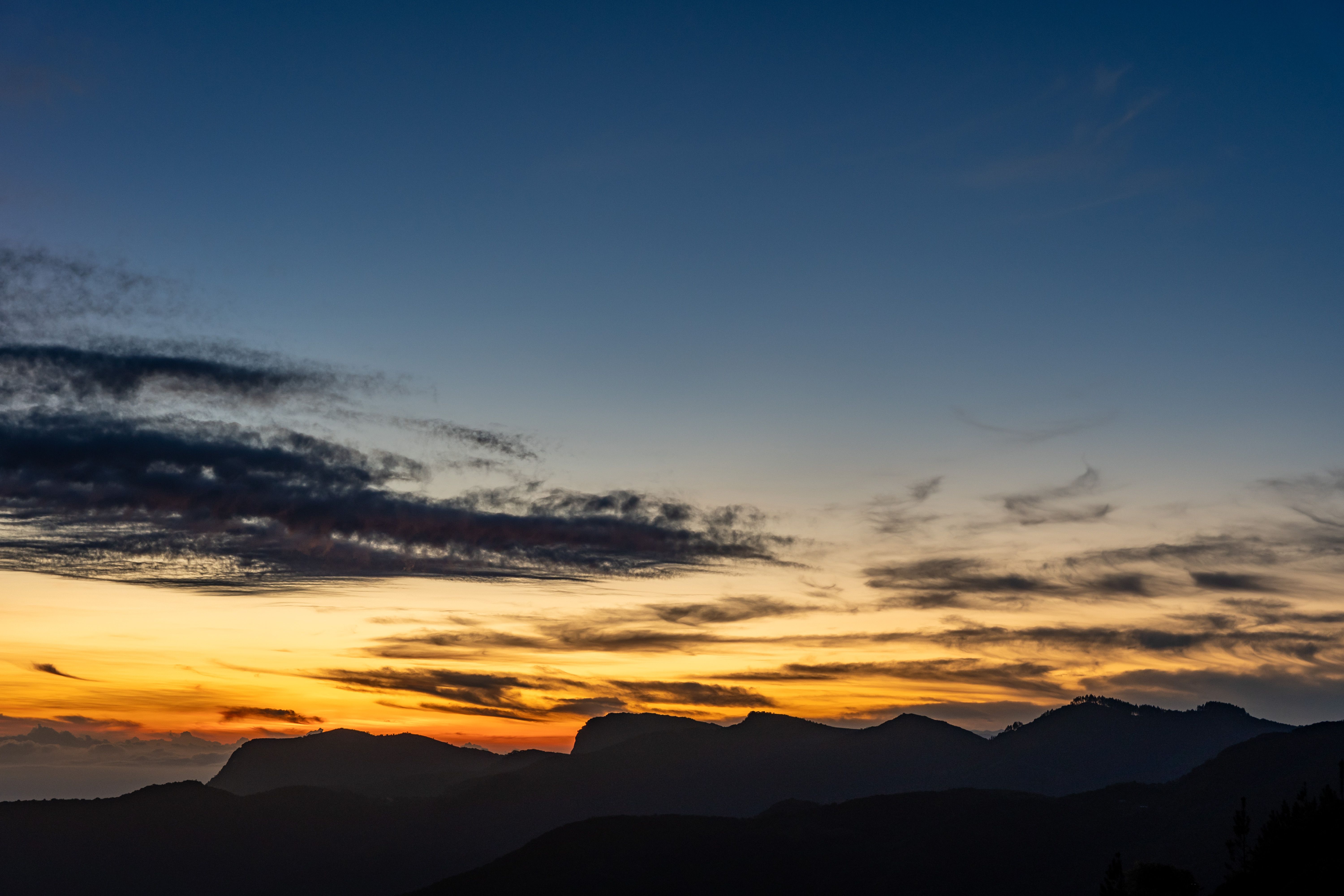 Clouds over Hills at Sunset · Free Stock Photo