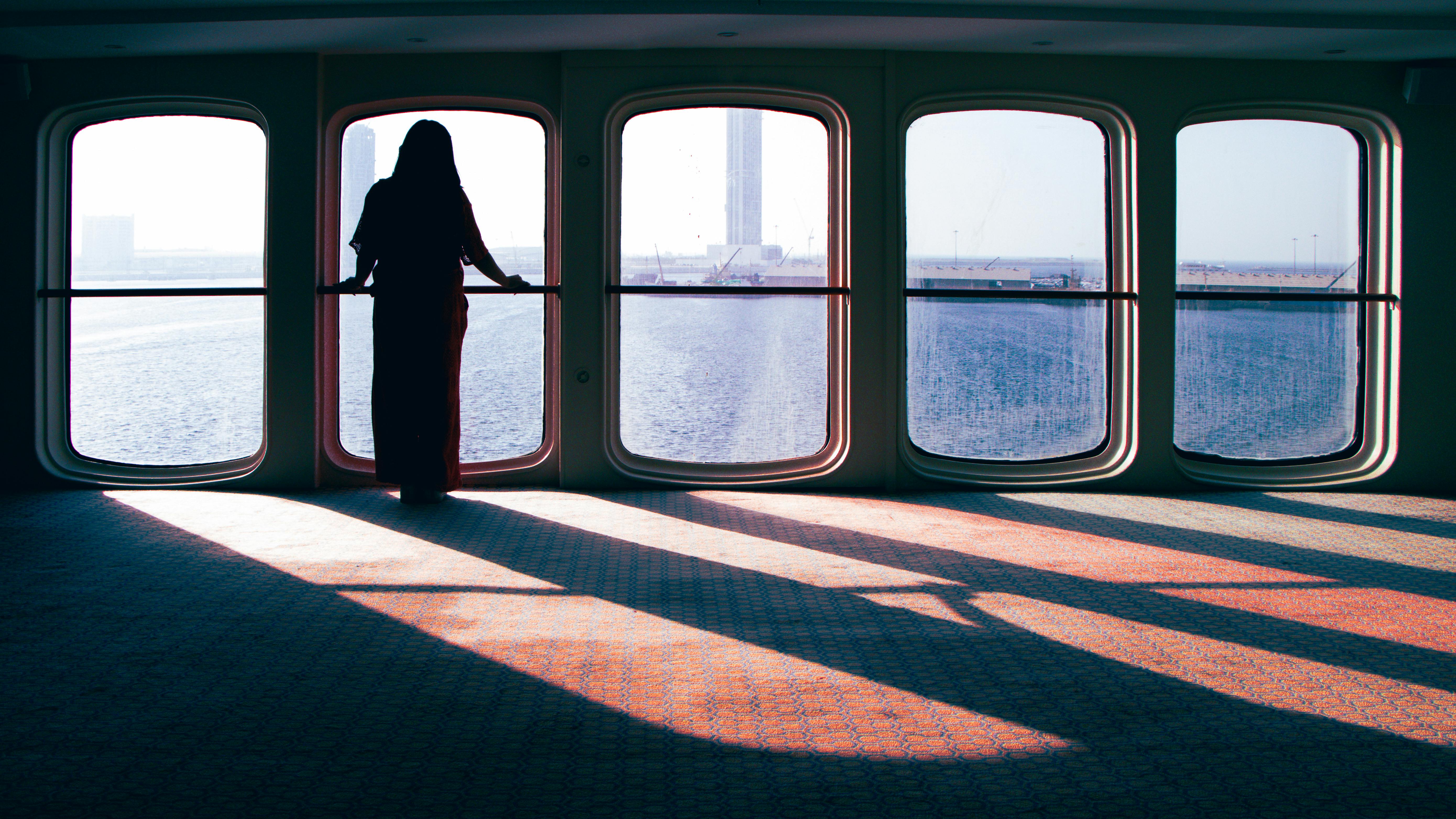 Silhouette at Large Ship Windows Overlooking Dubai · Free Stock Photo