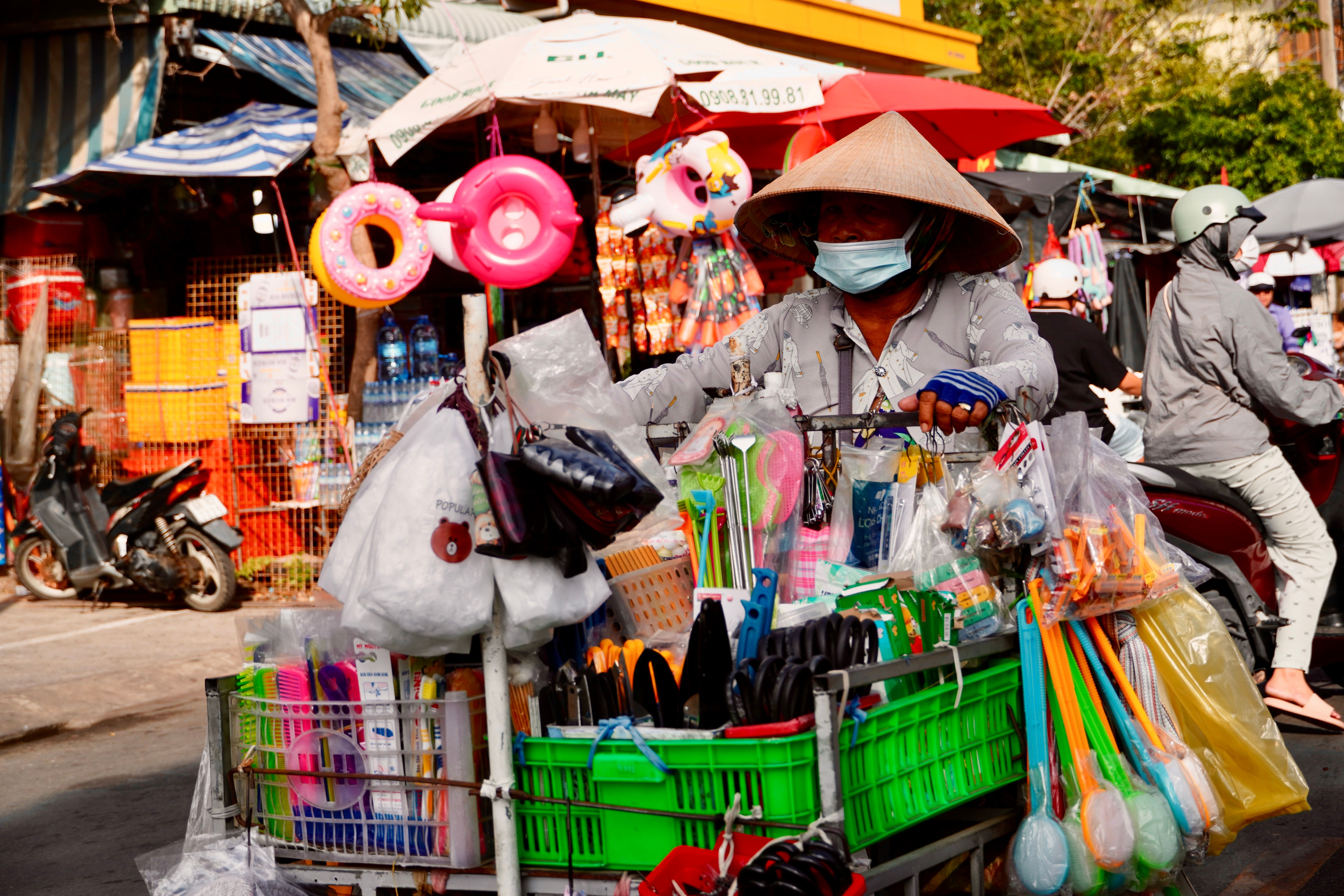 Street Vendor Selling Household Items in a Bustling Market · Free Stock ...