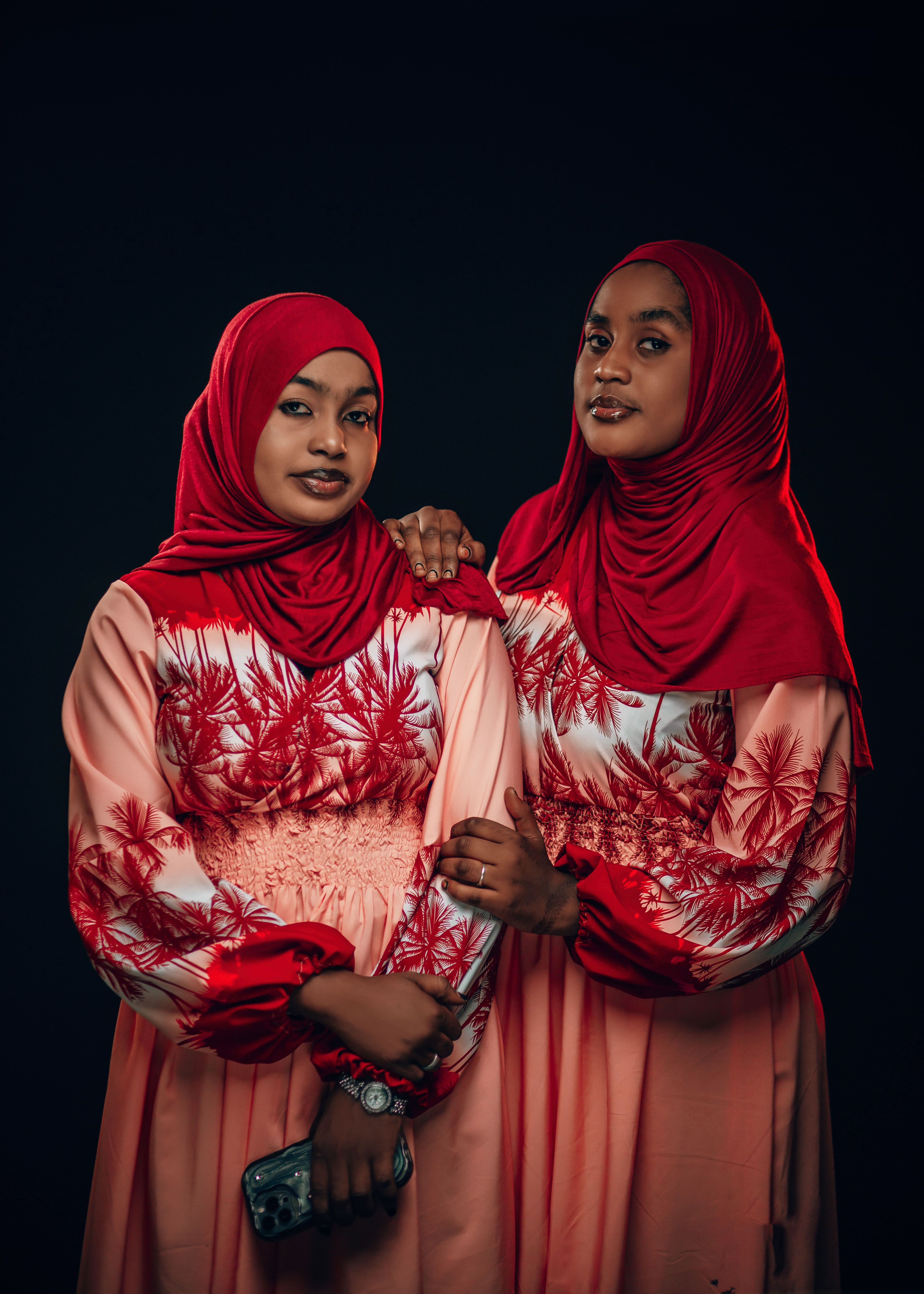 Elegant Portrait of Two Women in Red Hijabs · Free Stock Photo