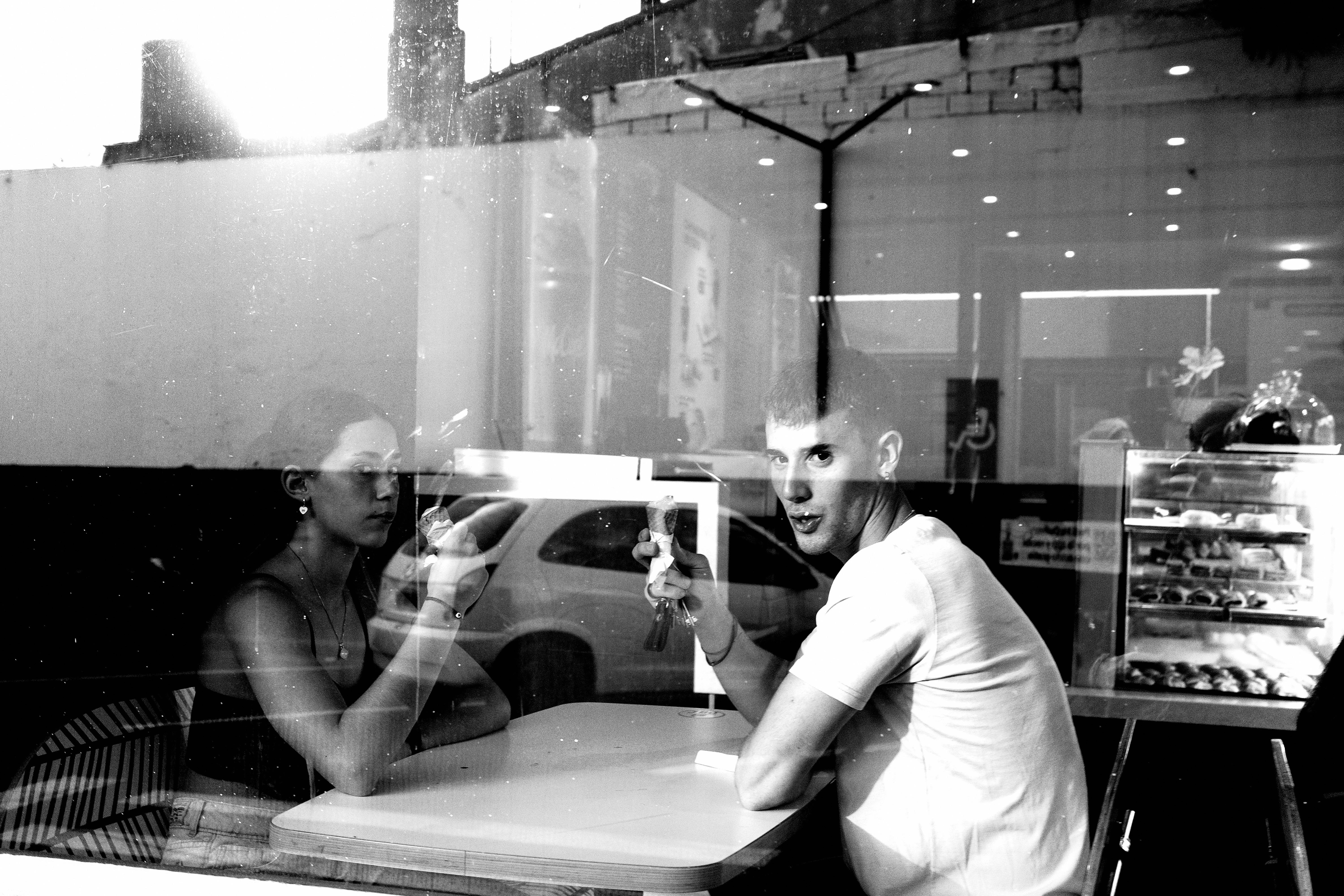 Monochrome Café Reflection of Two People · Free Stock Photo