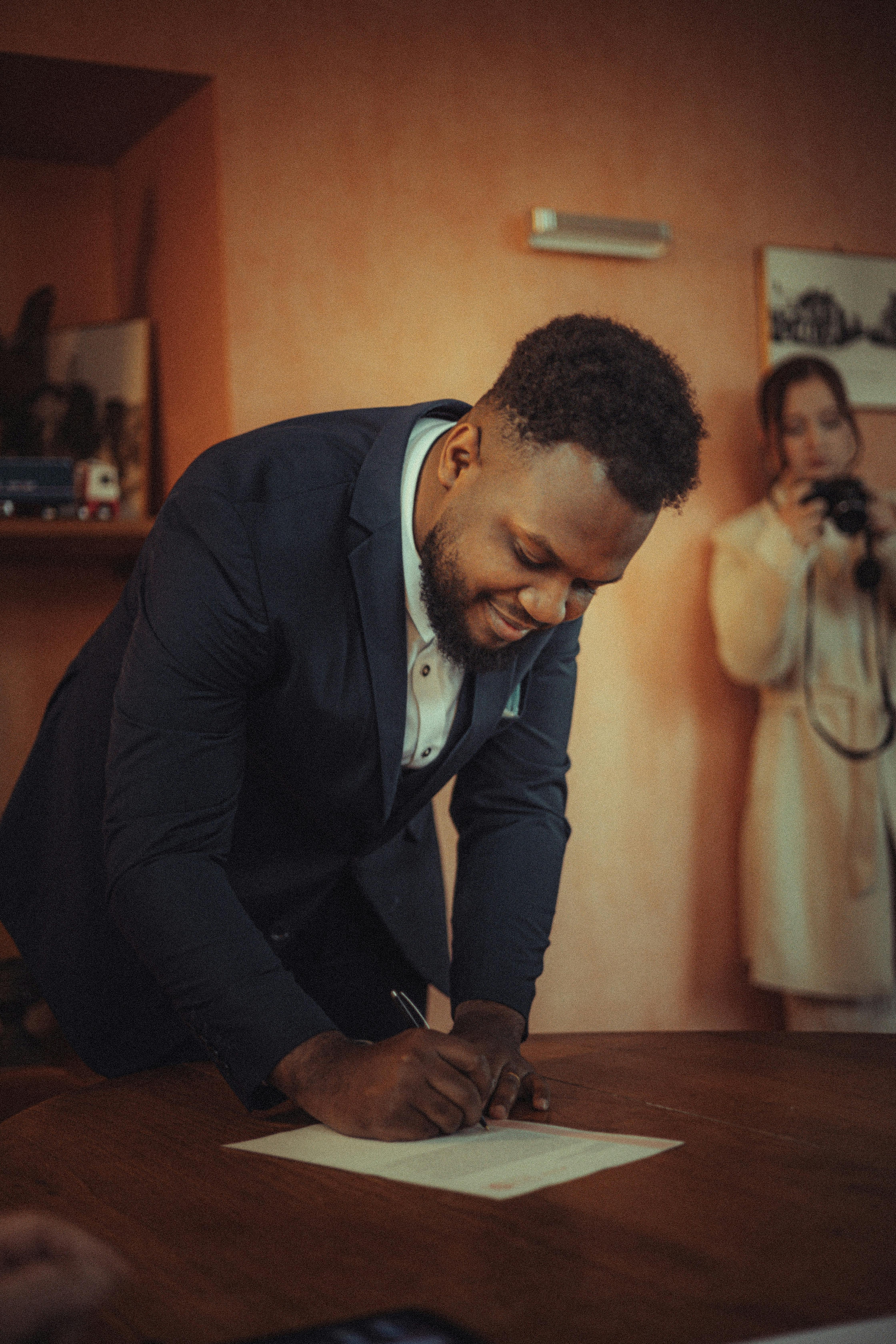 Man Signing Document at Formal Event · Free Stock Photo