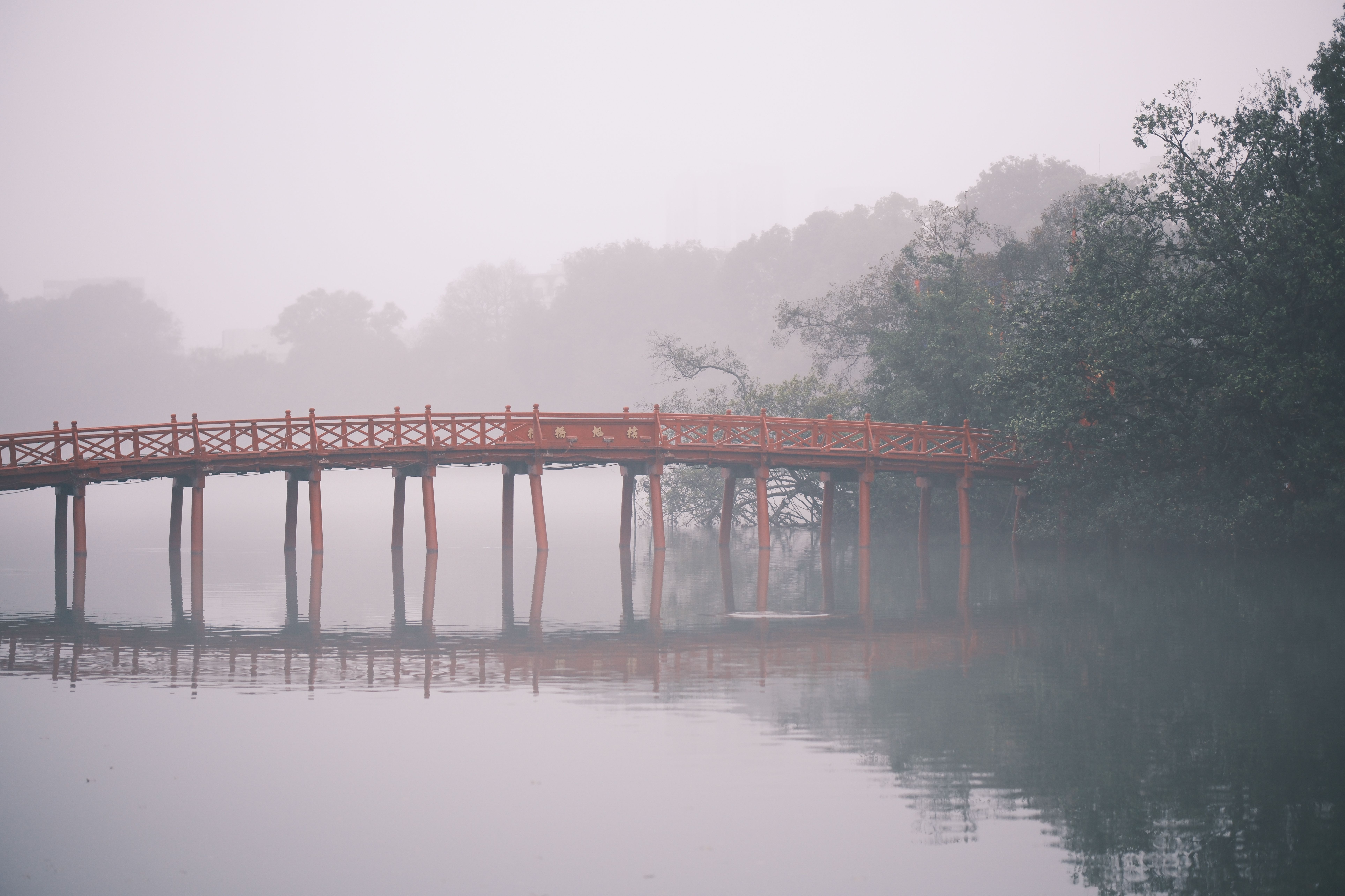 Serene Wooden Bridge Over Misty Lake · Free Stock Photo