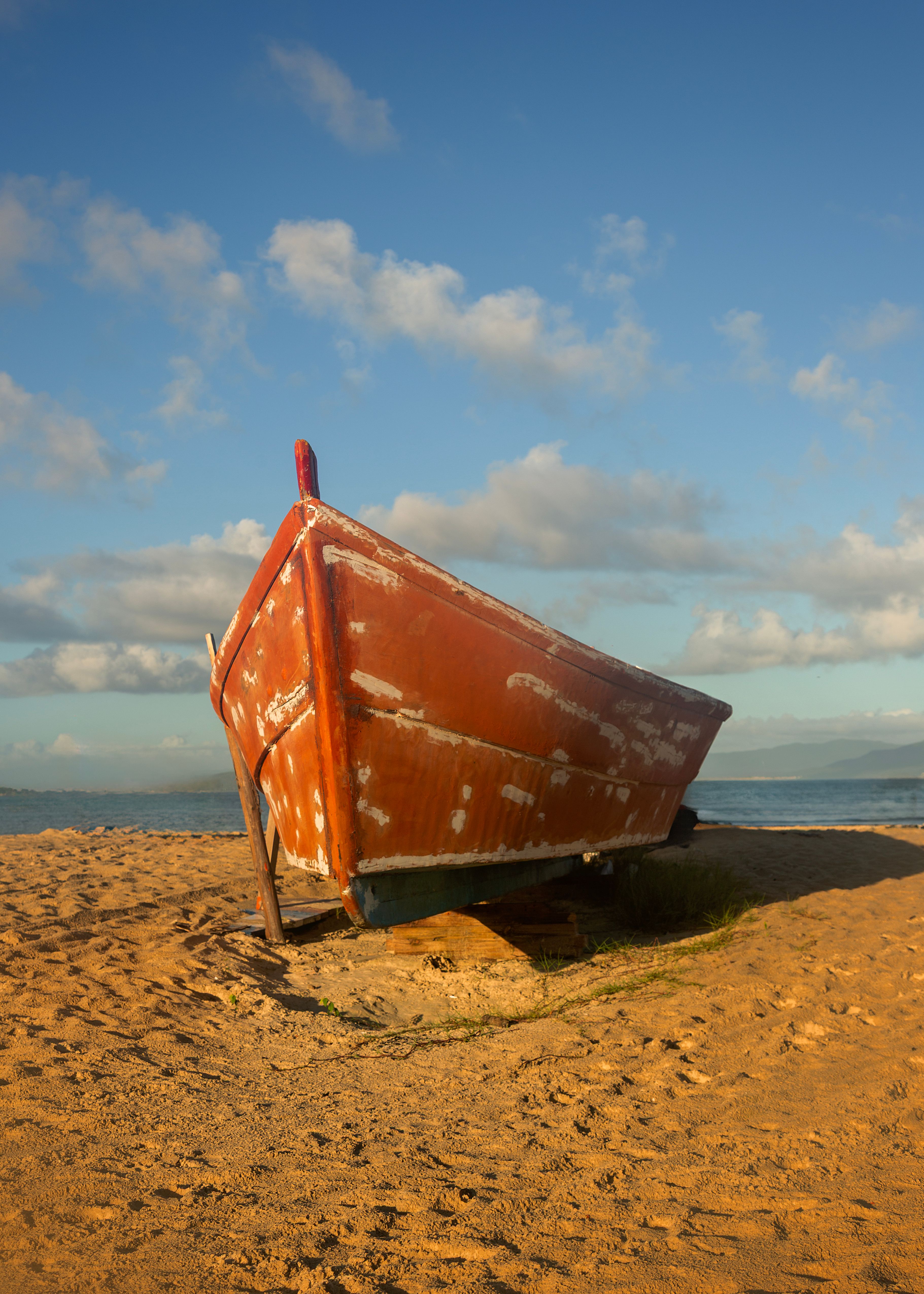 Weathered Red Boat on Sandy Beach in Sunlight · Free Stock Photo