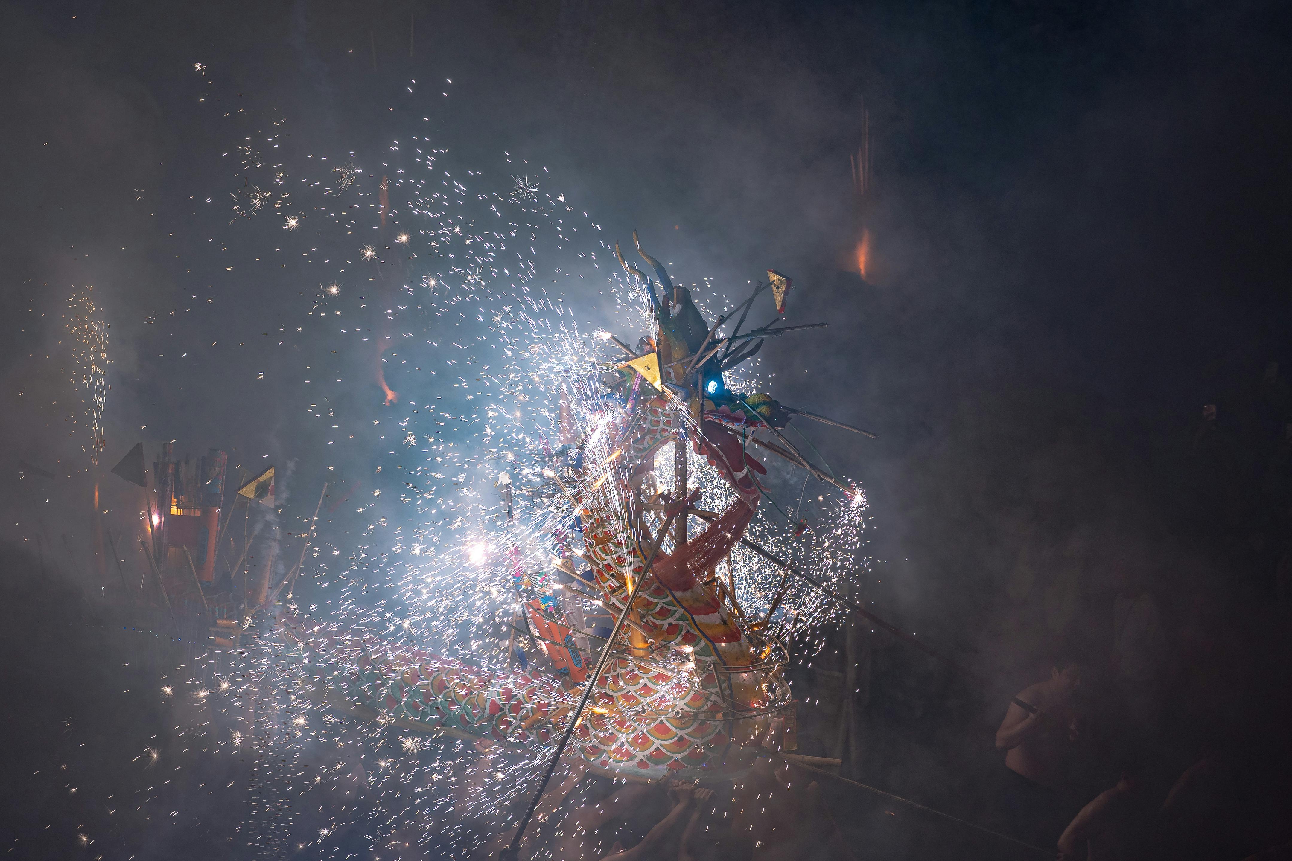 Vibrant Fireworks Exploding on Dragon Figure at Night · Free Stock Photo