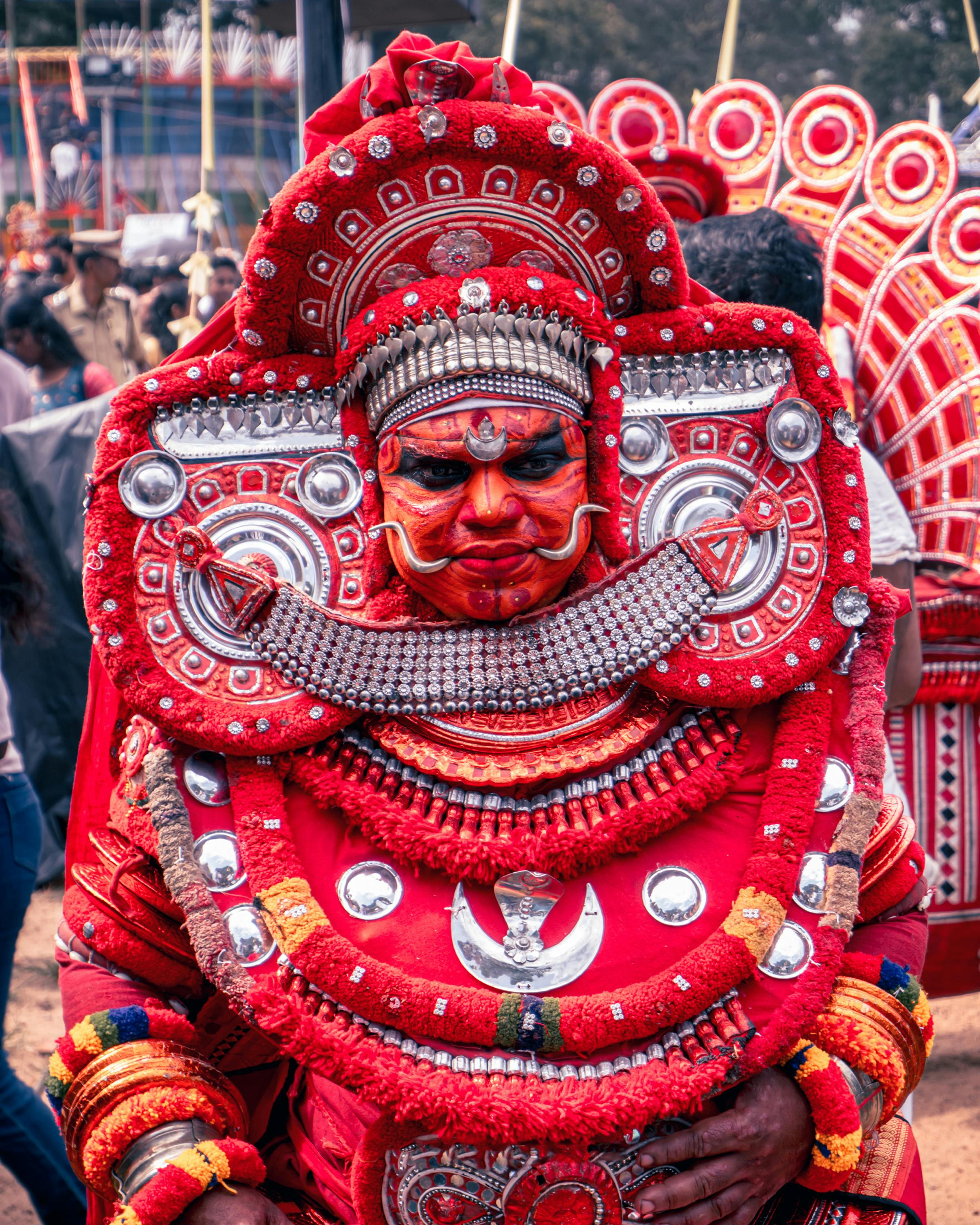 Vibrant Theyyam performer in traditional costume · Free Stock Photo