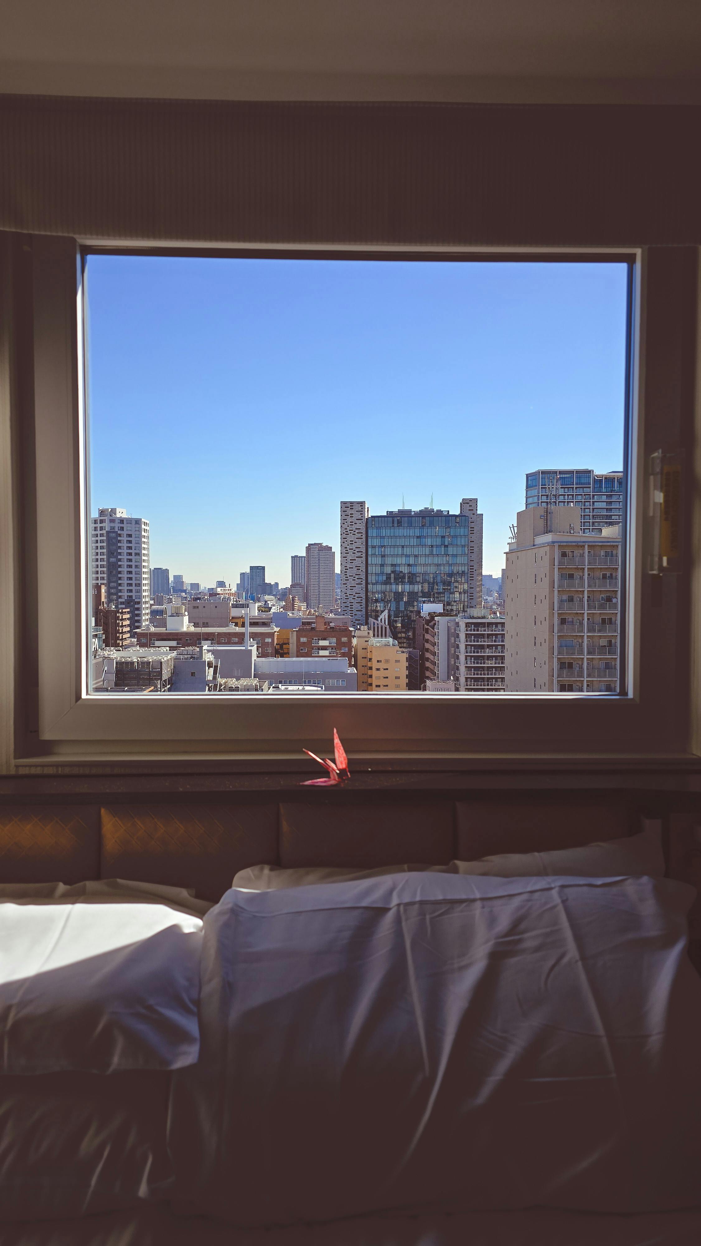 Urban Window View Framing Cityscape Skyline · Free Stock Photo