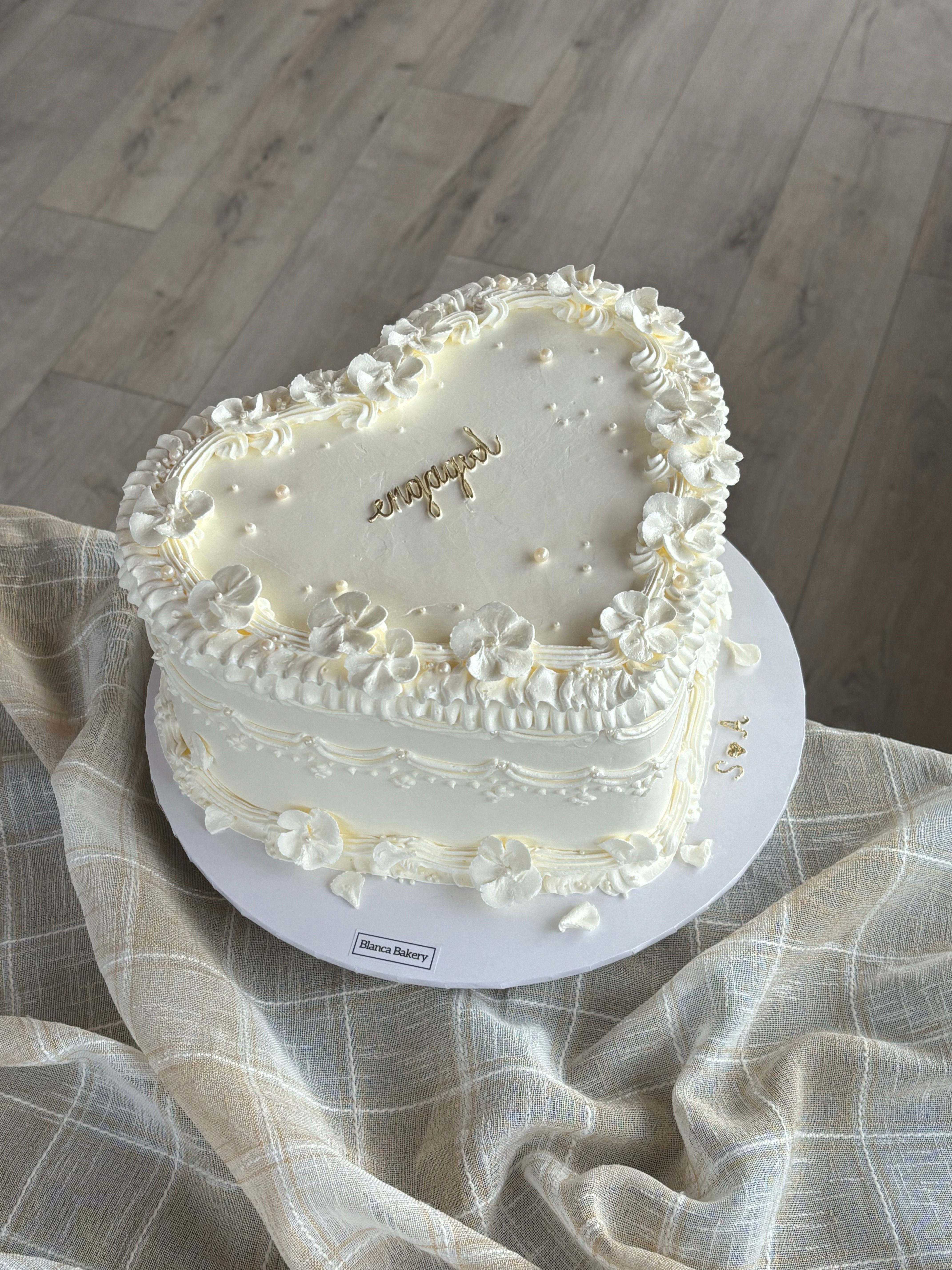 Elegant Heart-Shaped White Cake on Display · Free Stock Photo