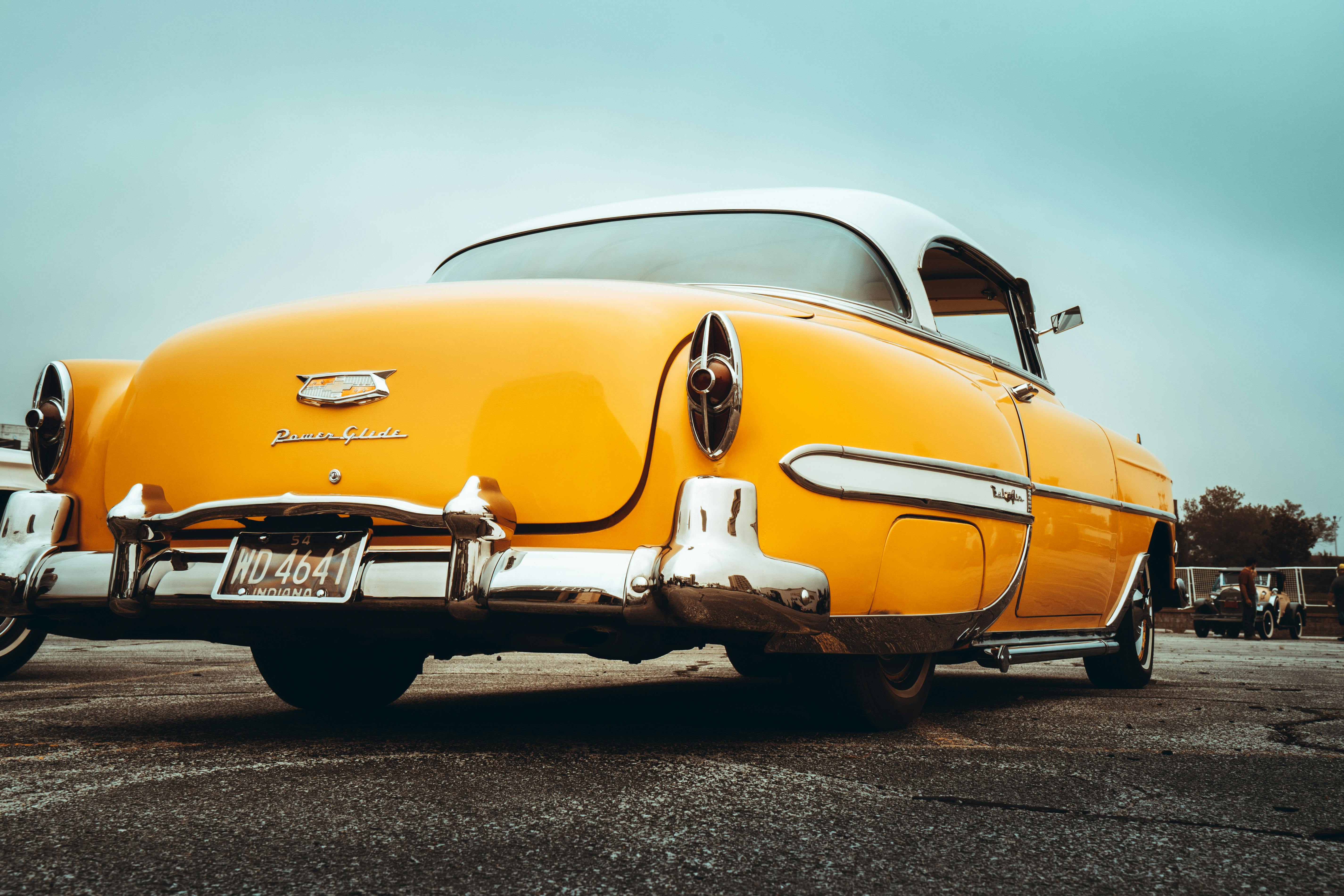 Vintage Yellow Classic American Car Outdoors · Free Stock Photo