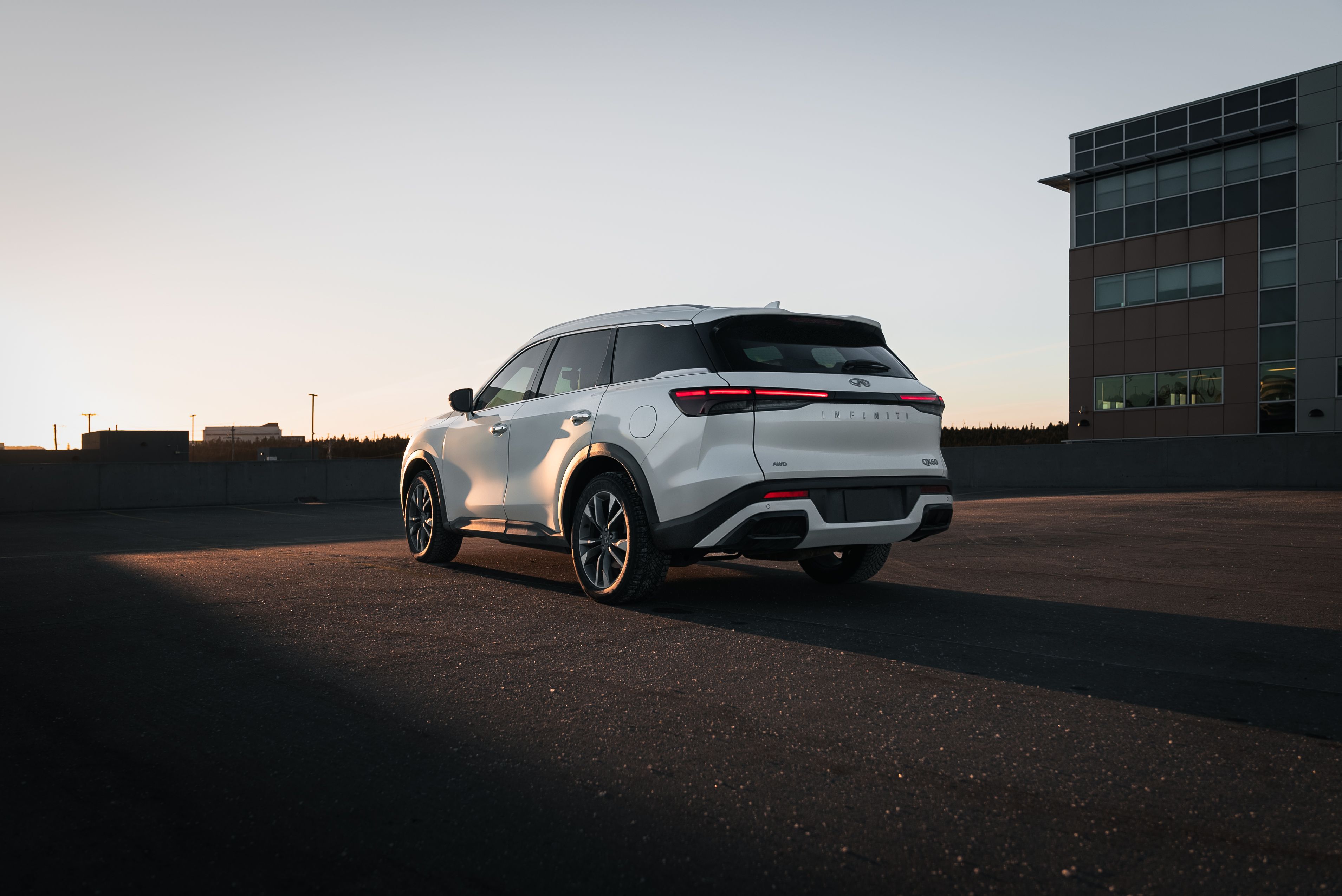 Sleek White SUV at Sunset on Urban Rooftop · Free Stock Photo