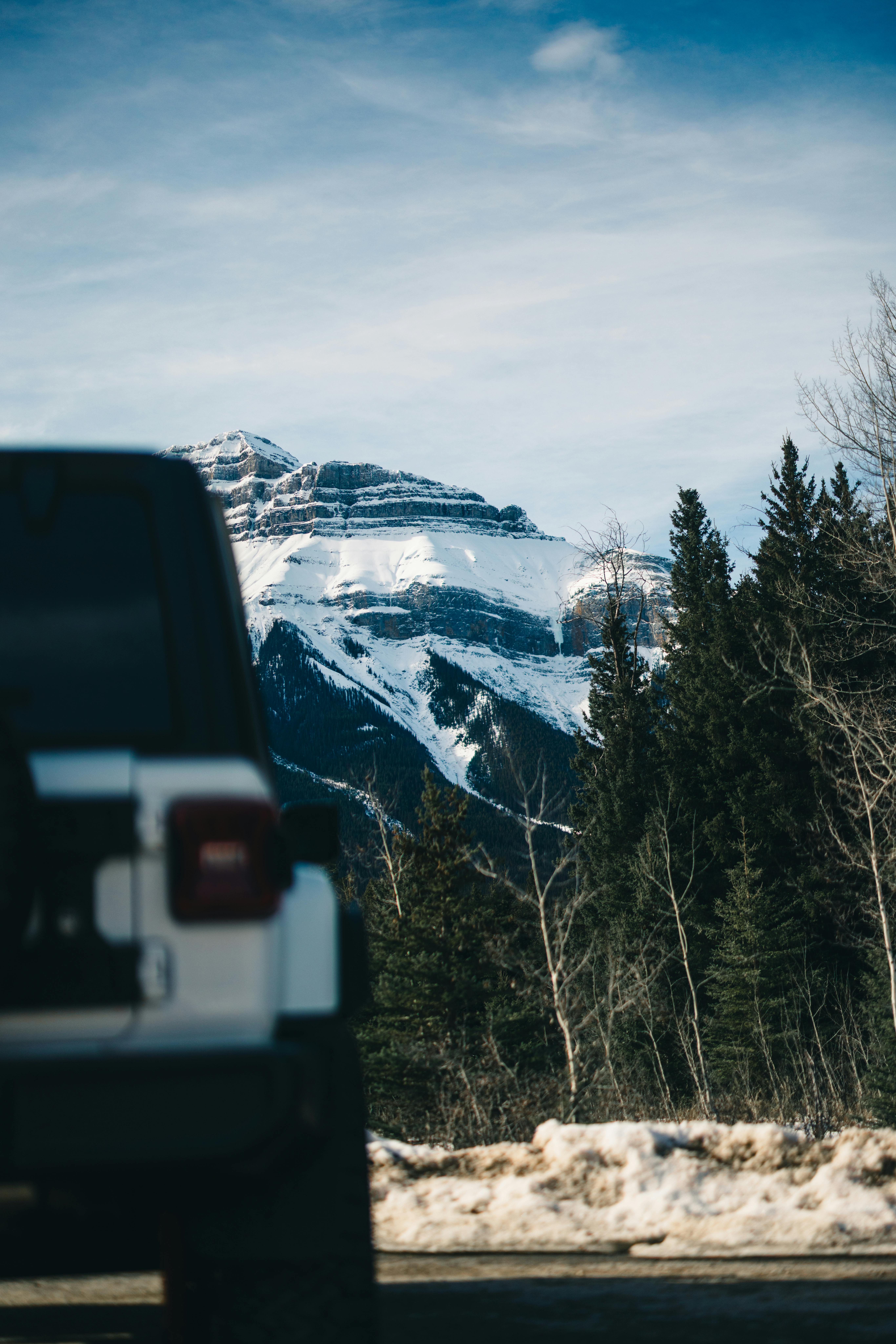 Jeep Parked with Snowy Mountain View in Jasper · Free Stock Photo