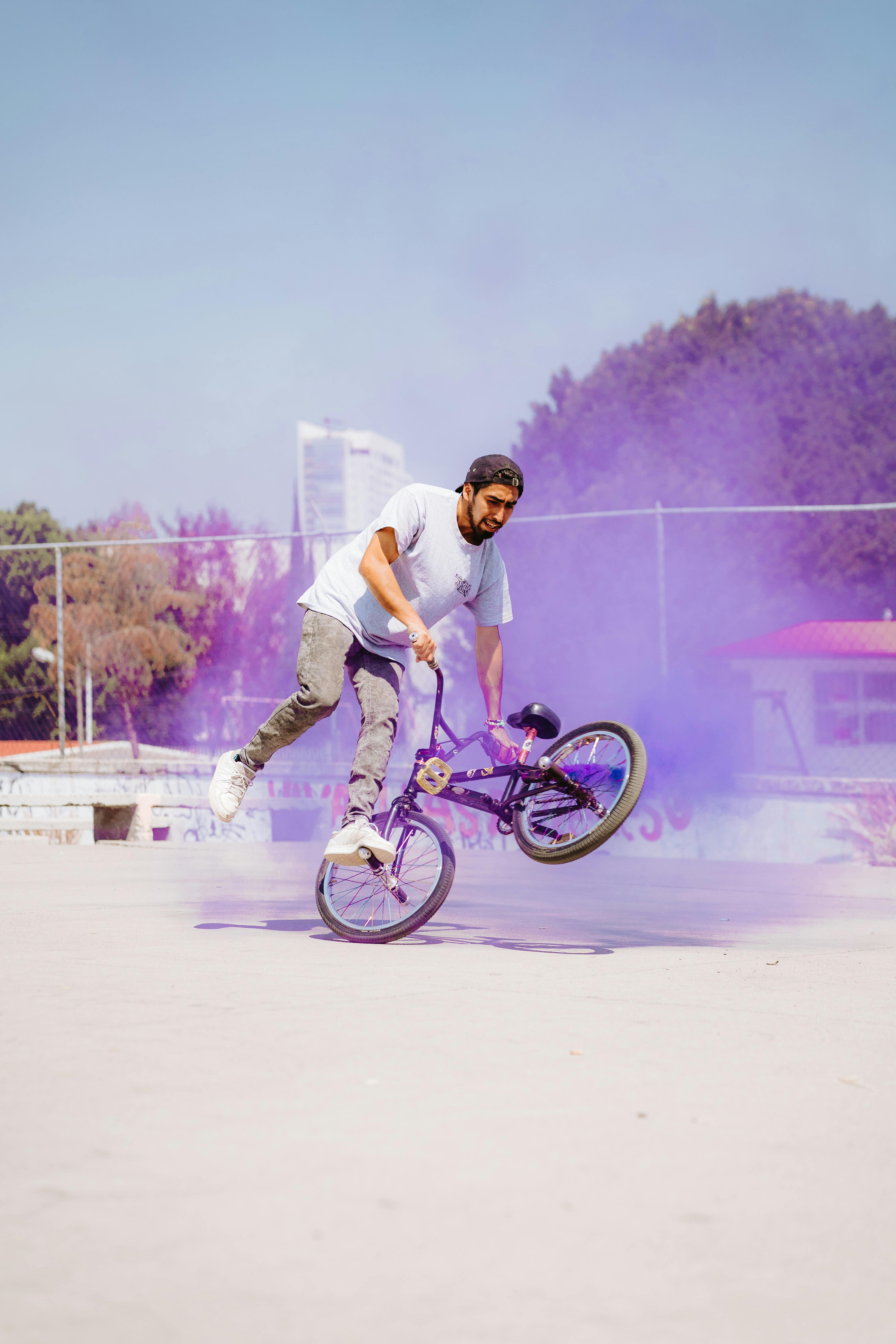 Dynamic BMX Stunt Performance with Purple Smoke · Free Stock Photo