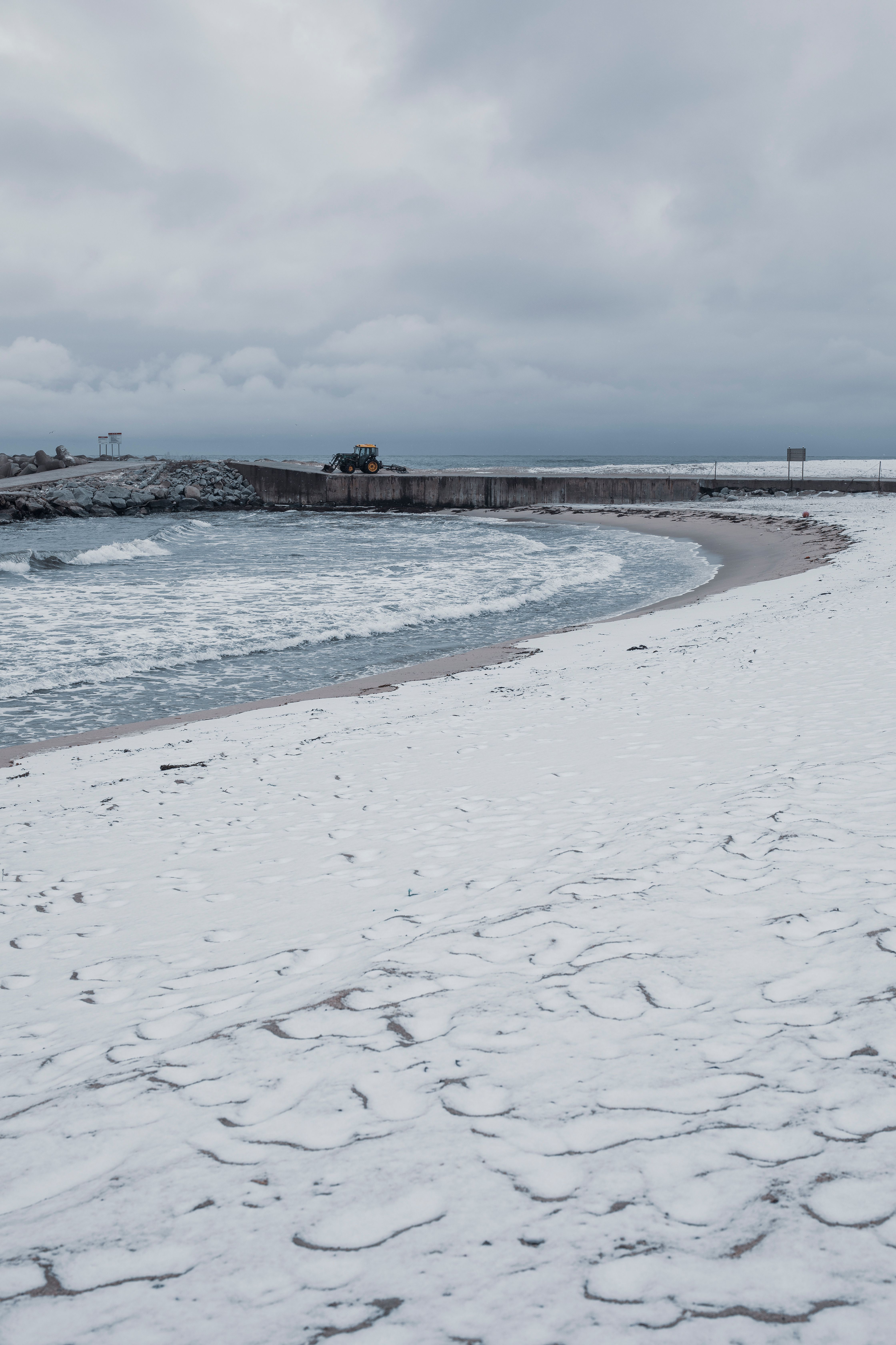 Snow-Covered Beach by the Ocean in Wintertime · Free Stock Photo