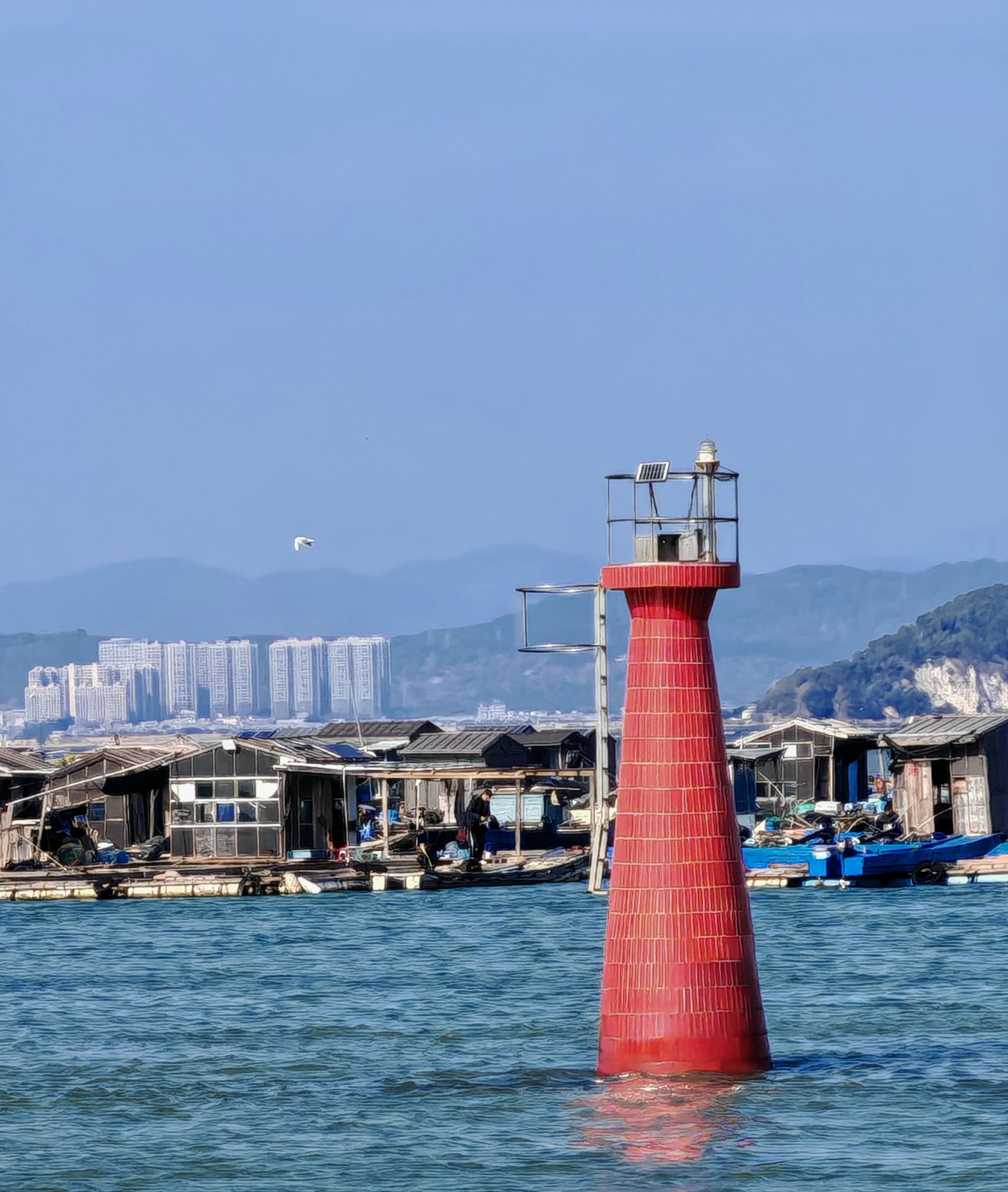 Red Lighthouse in Coastal Fishing Village · Free Stock Photo
