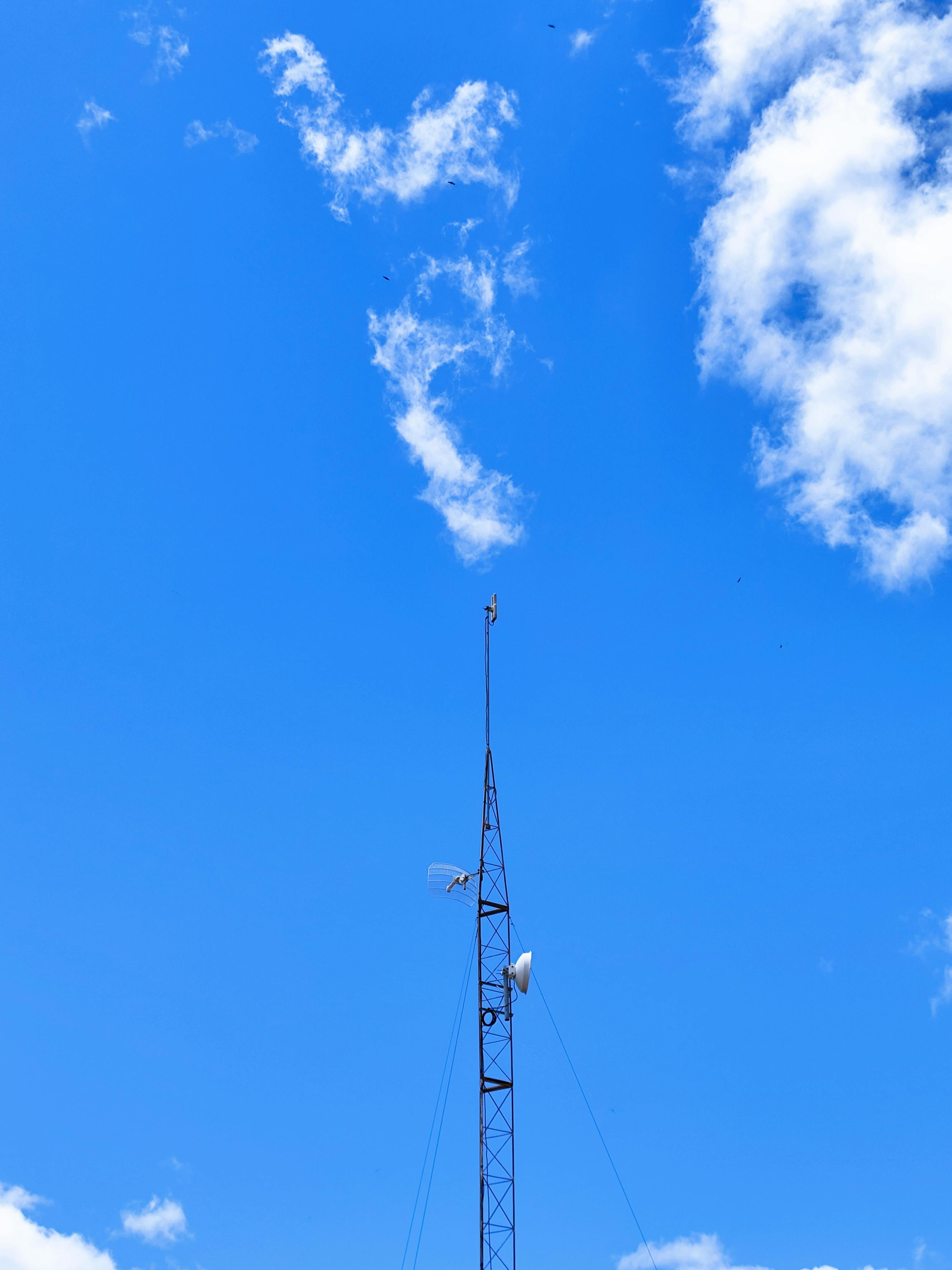 Tall Radio Tower Against Bright Blue Sky · Free Stock Photo