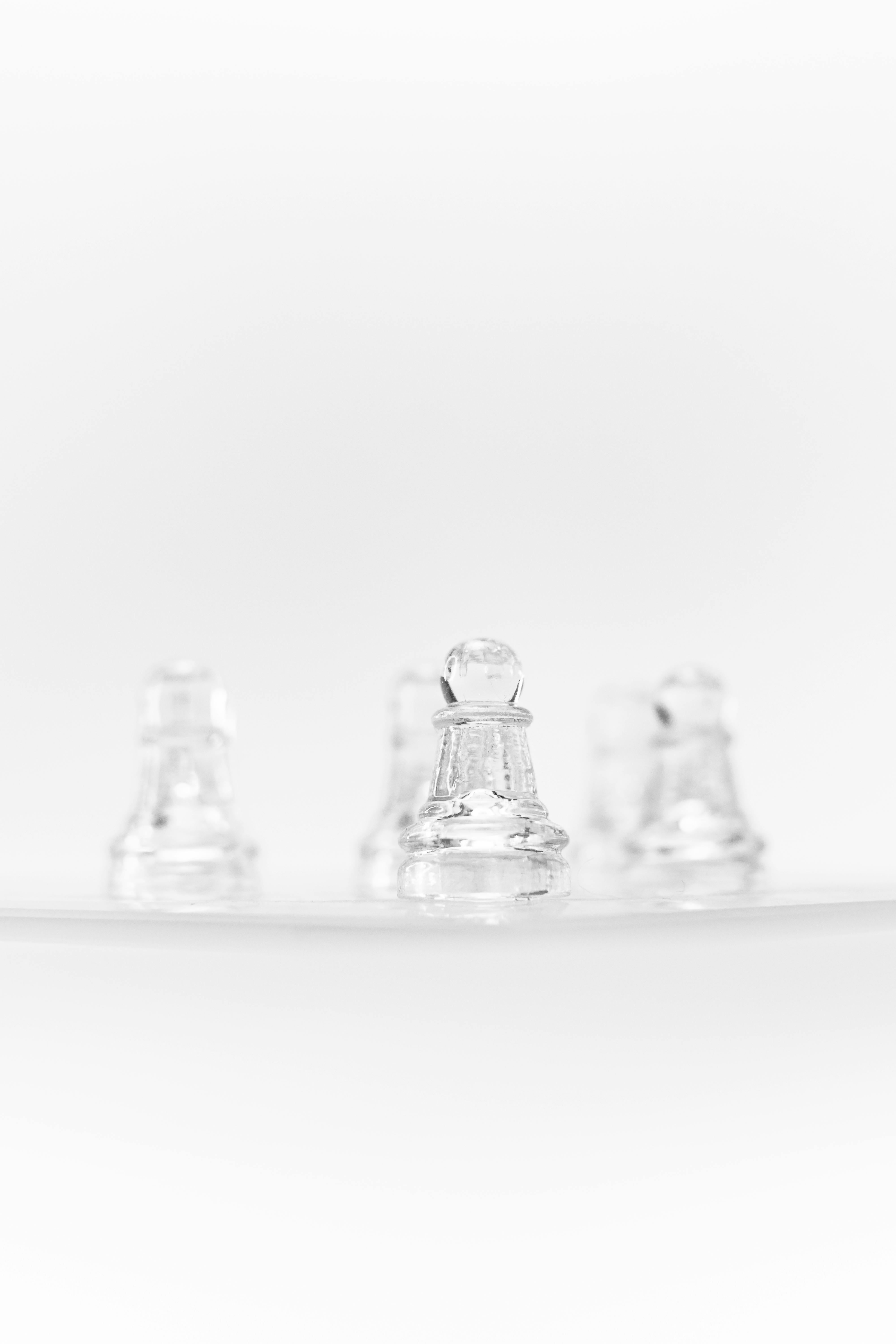 Minimalist Glass Chess Pieces on a White Background · Free Stock Photo