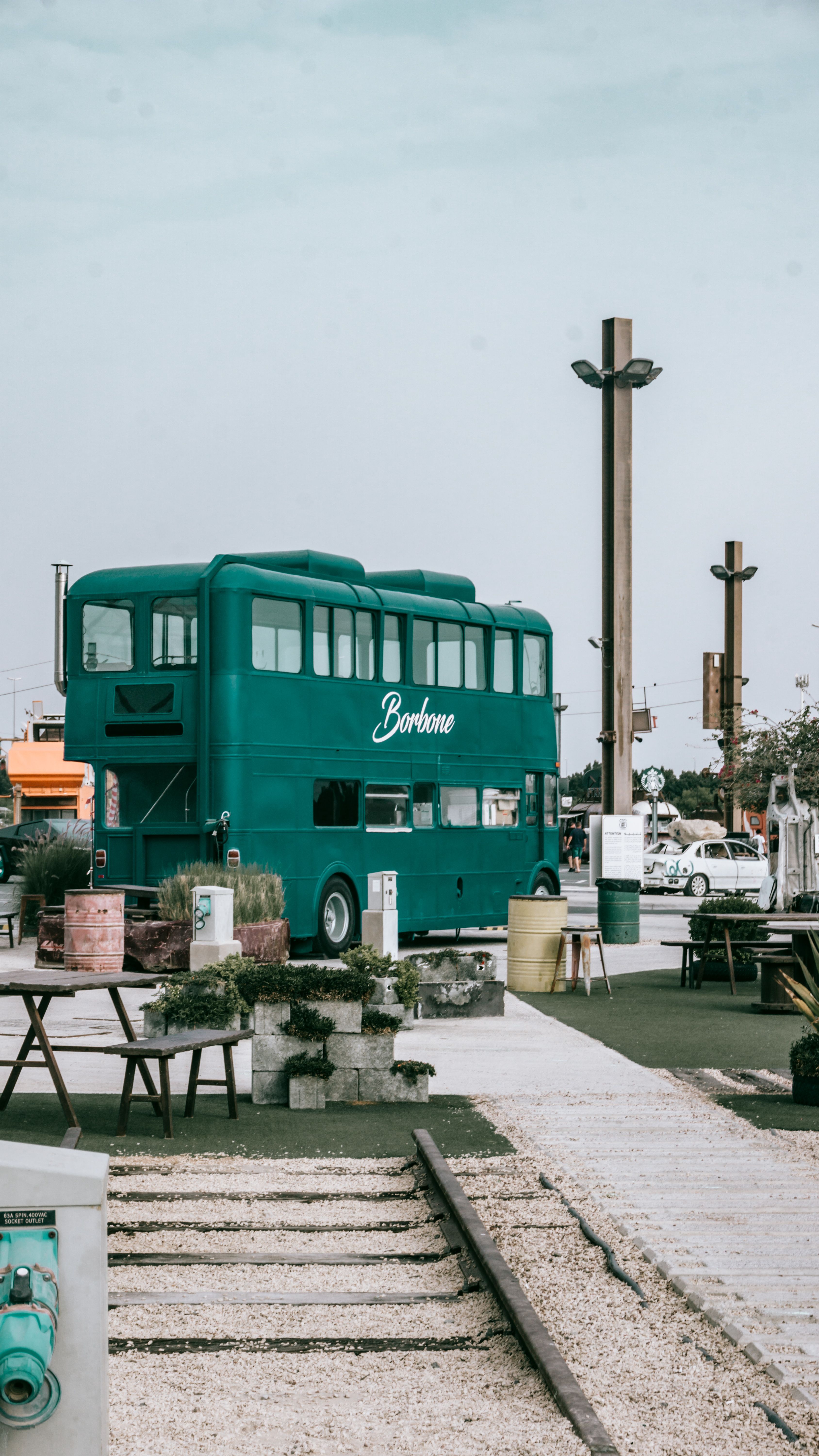 Vintage Double-Decker Bus in Outdoor Cafe Setting · Free Stock Photo