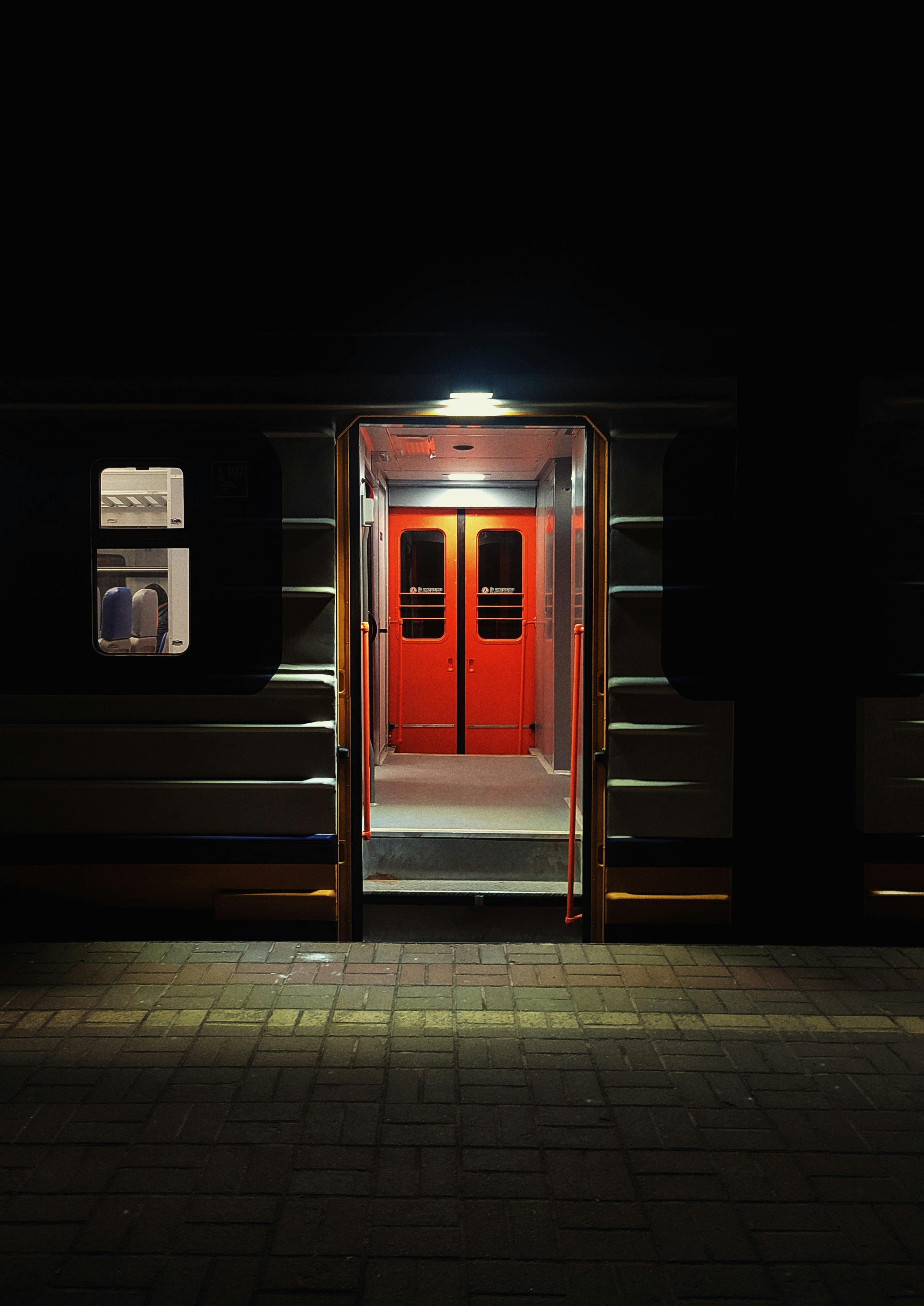 Nighttime Train Entrance with Red Doors · Free Stock Photo