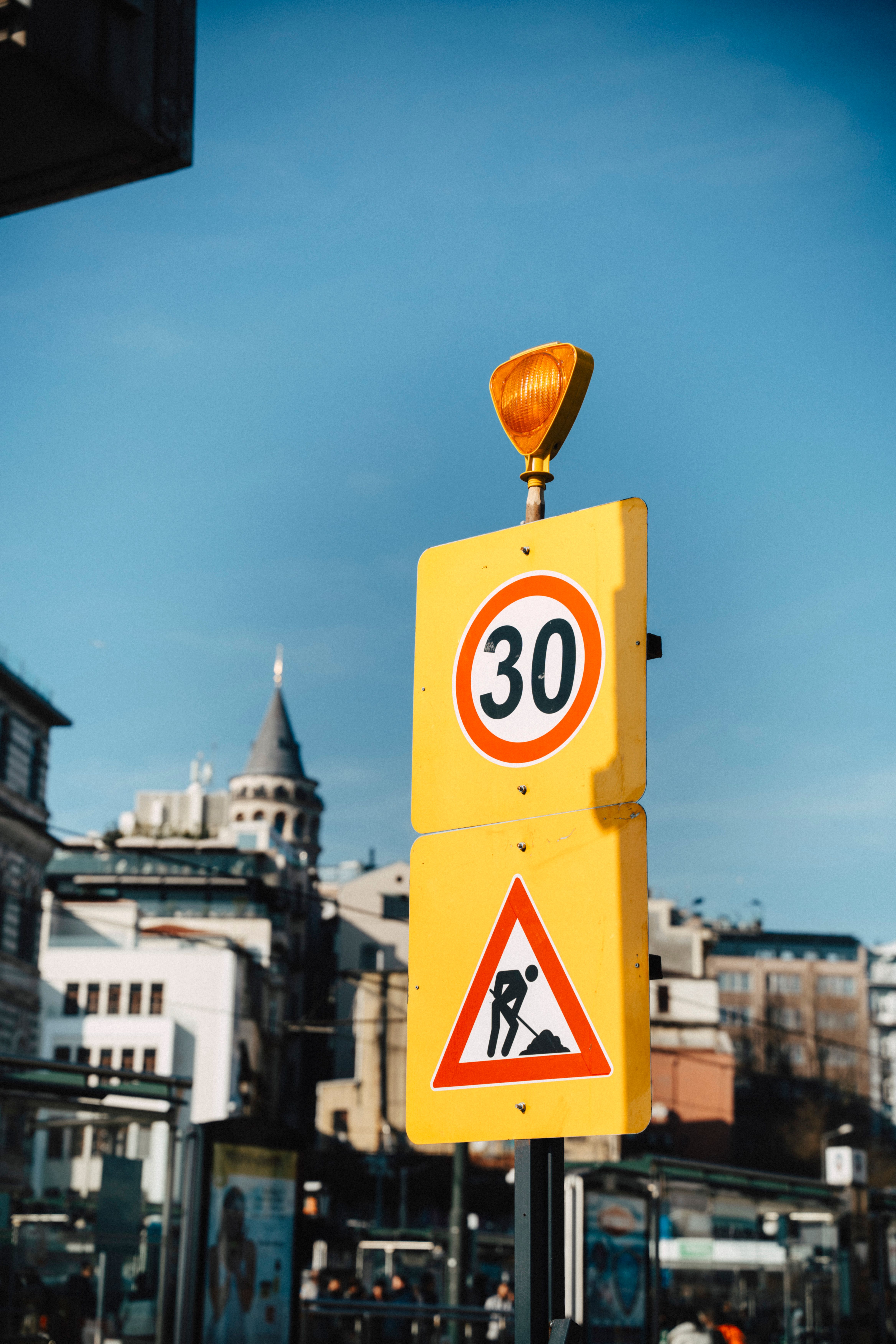 Urban Traffic Sign with Cityscape Background · Free Stock Photo