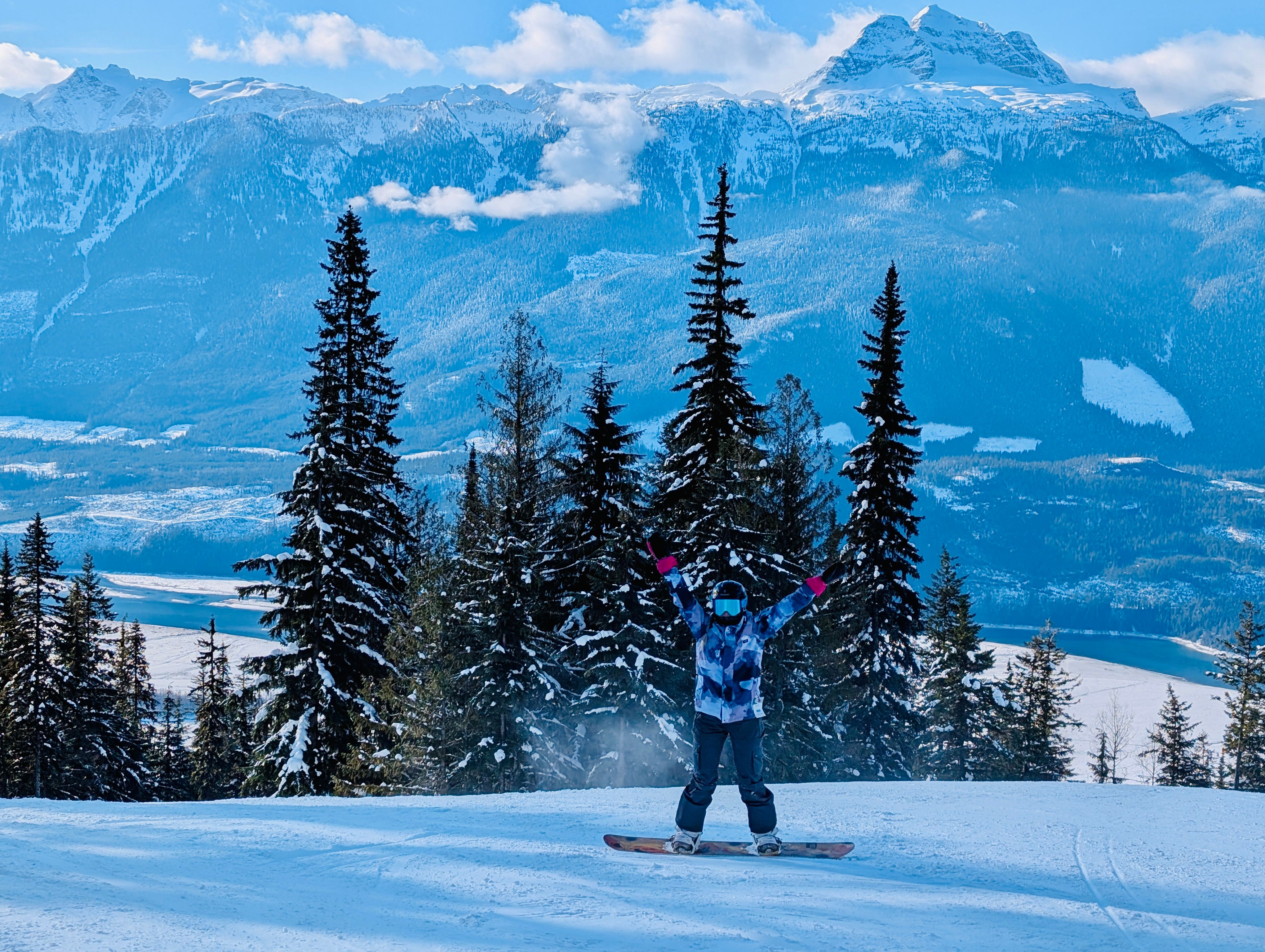 Snowboarder Celebrating on Scenic Mountain Slope · Free Stock Photo