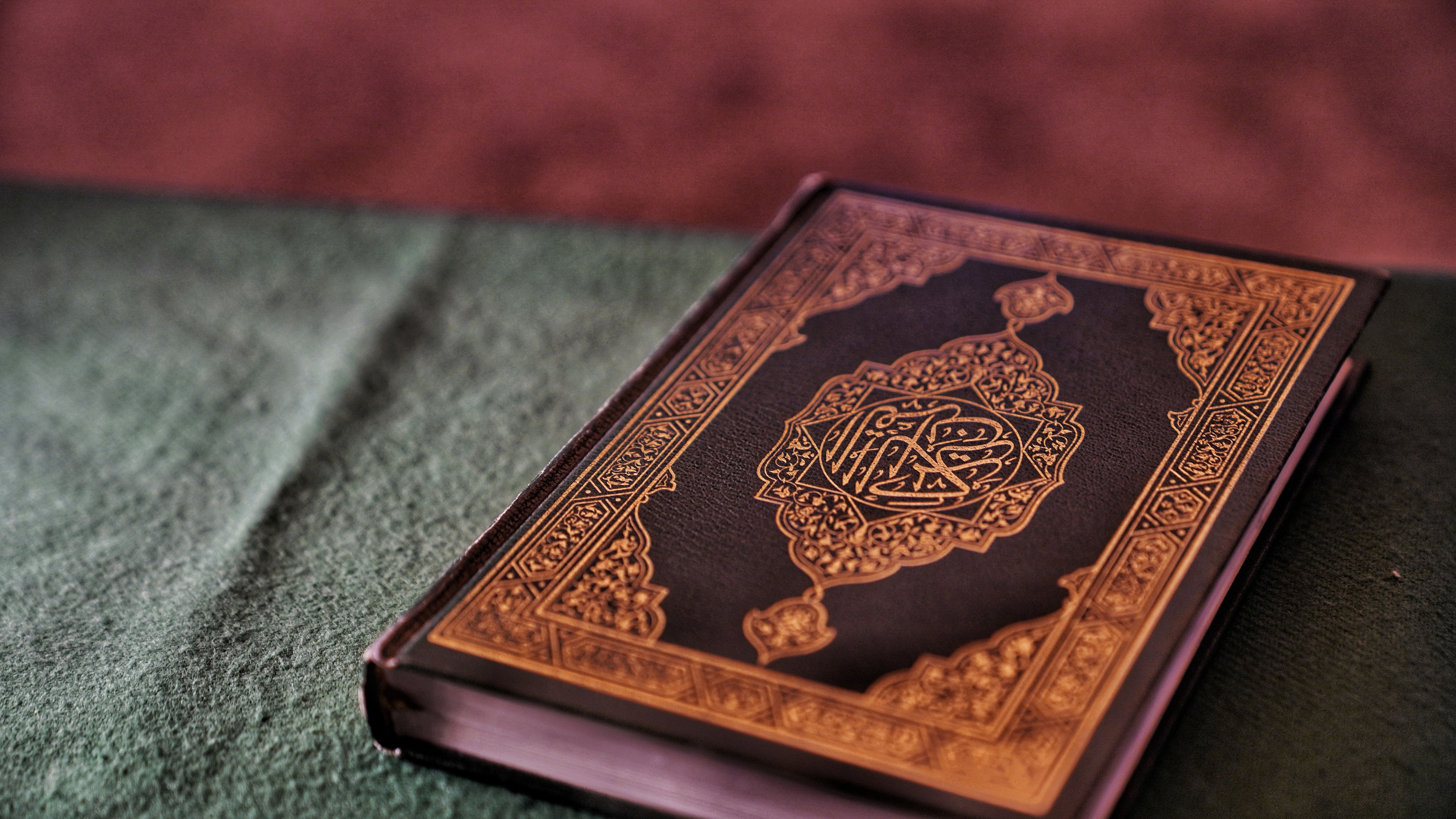 Ornate Quran on Green Felt Surface · Free Stock Photo