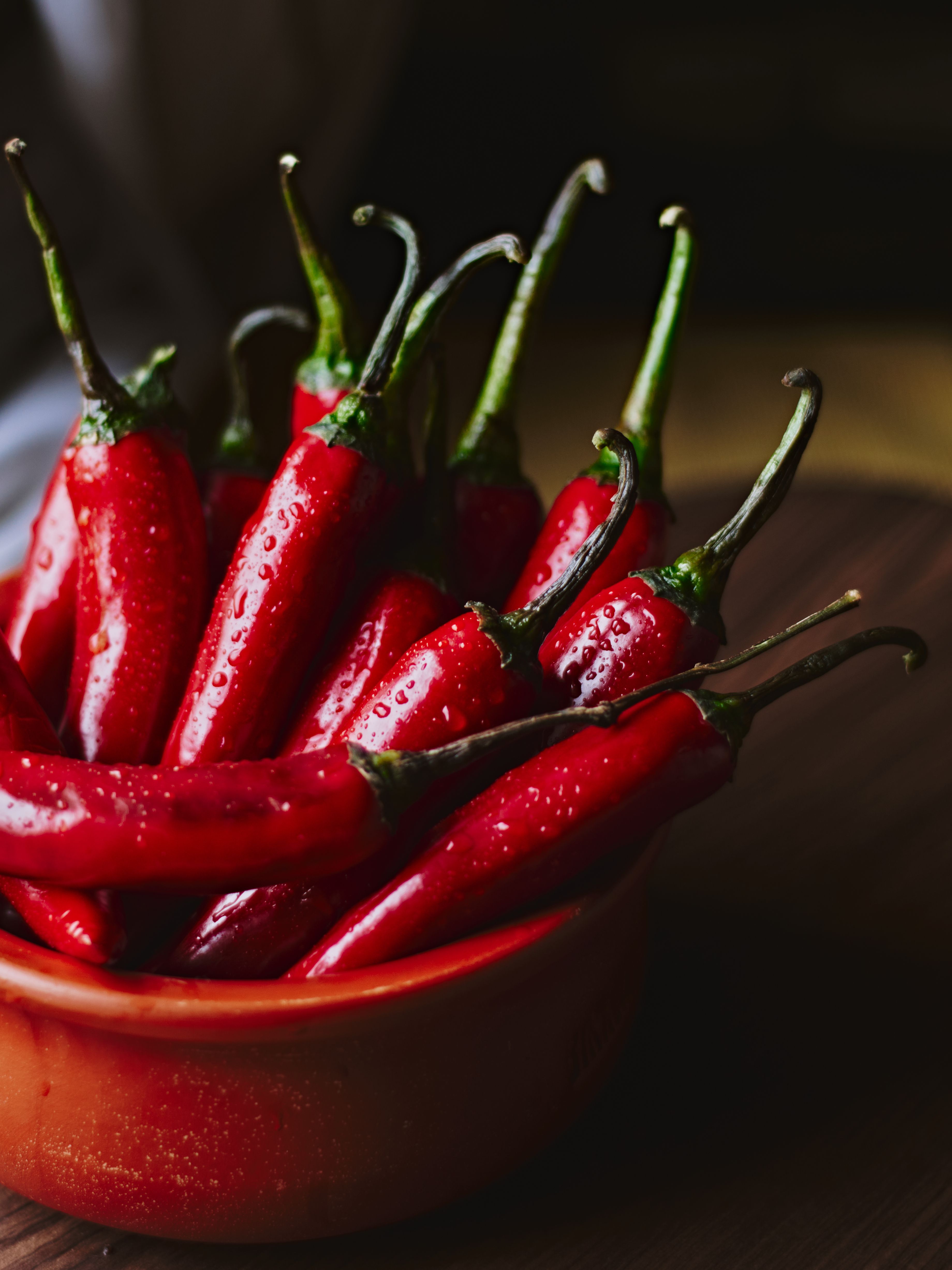 Vibrant Red Chili Peppers in Rustic Bowl · Free Stock Photo