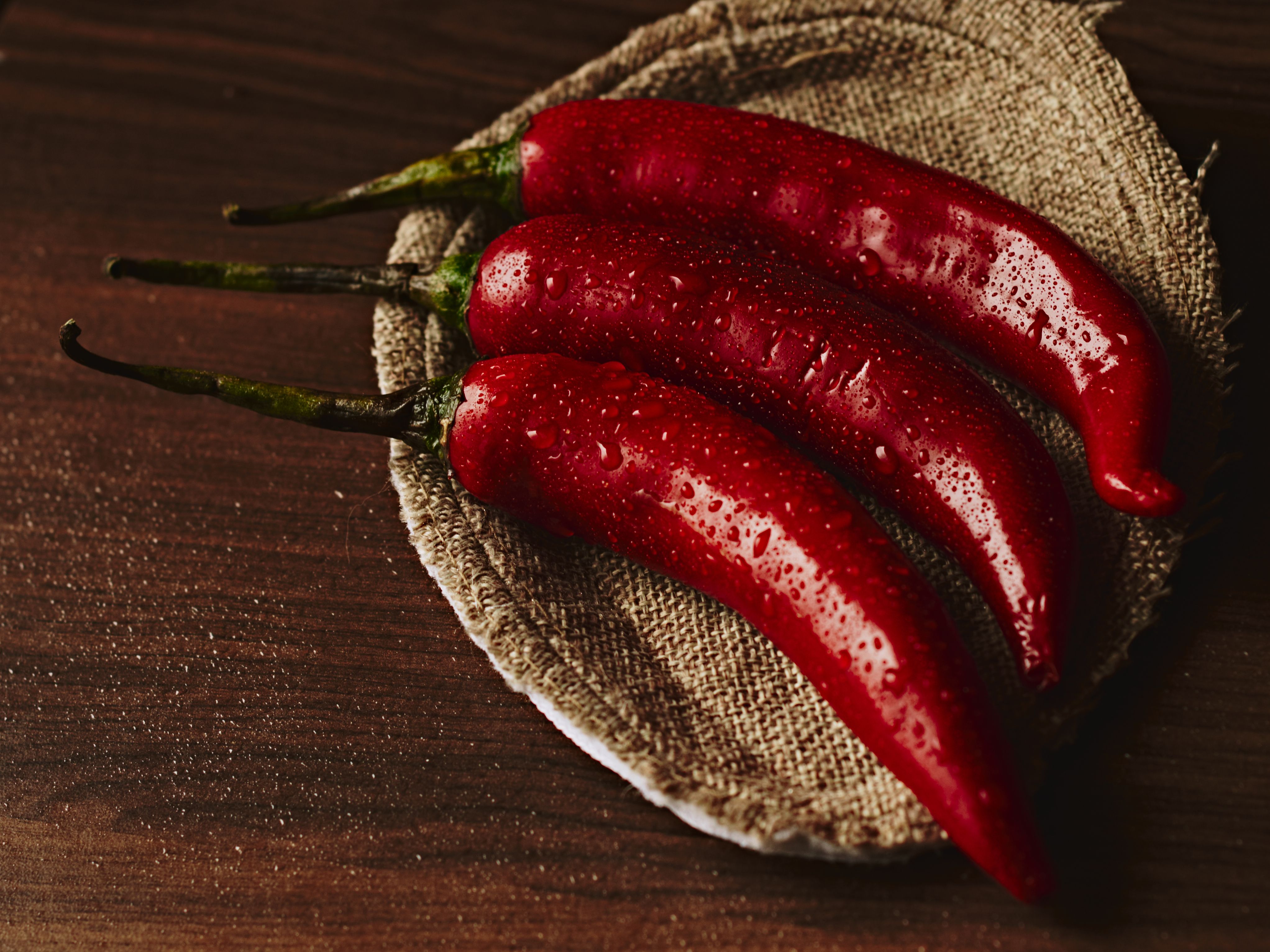 Fresh Red Chili Peppers on Burlap Cloth · Free Stock Photo