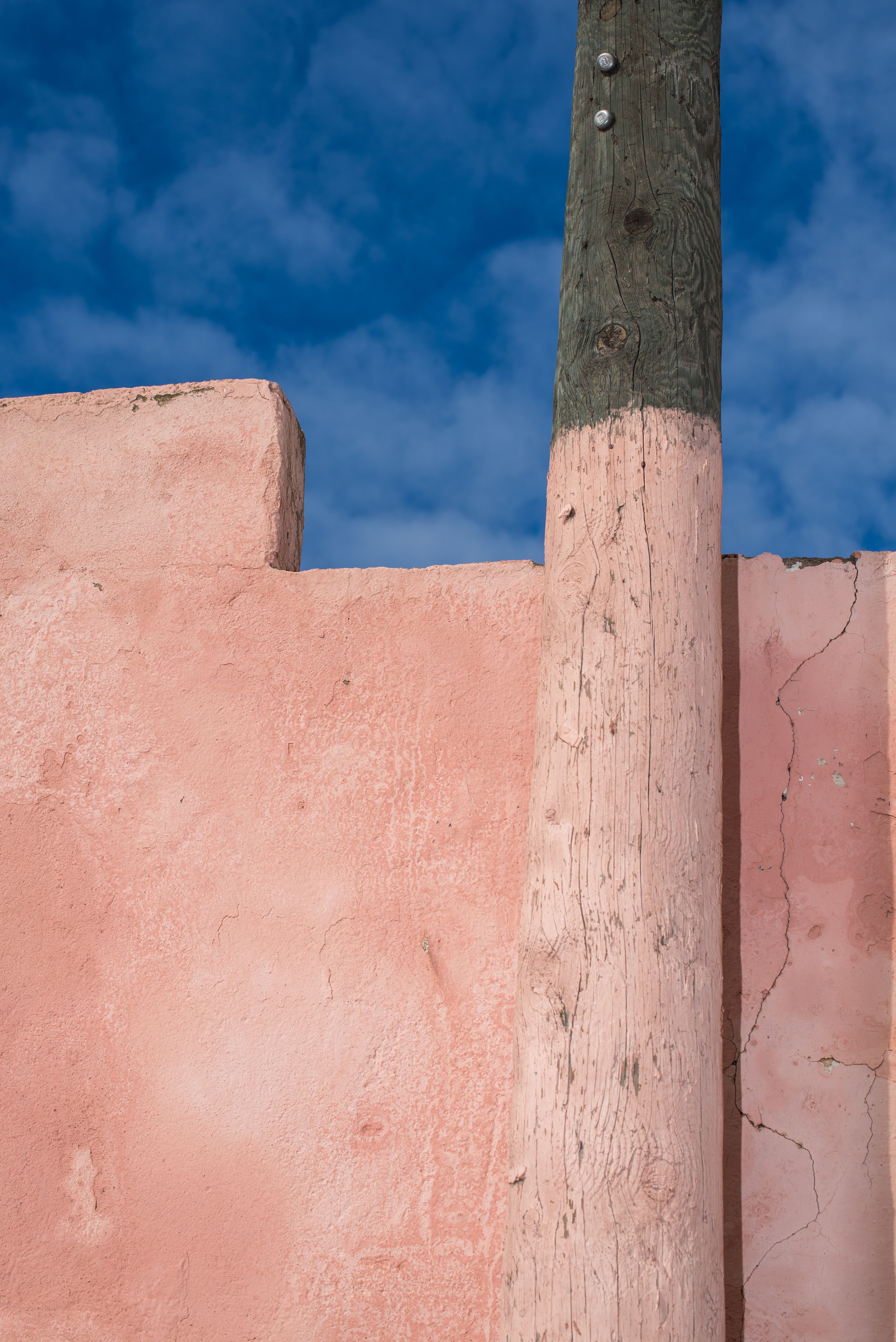 Pastel Pink Wall with Rustic Wooden Pole · Free Stock Photo