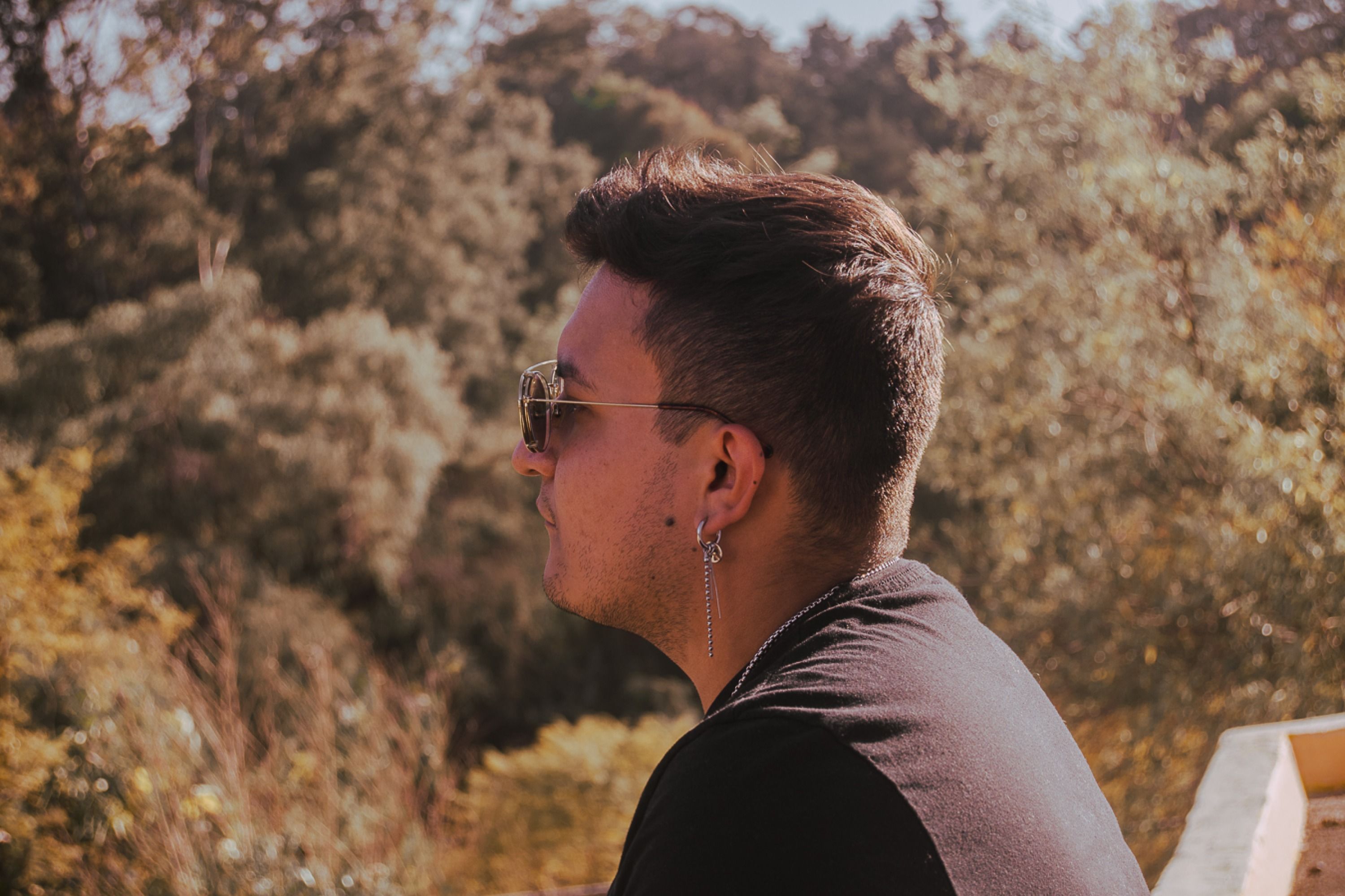 Stylish Man Gazing in Nature's Tranquility · Free Stock Photo