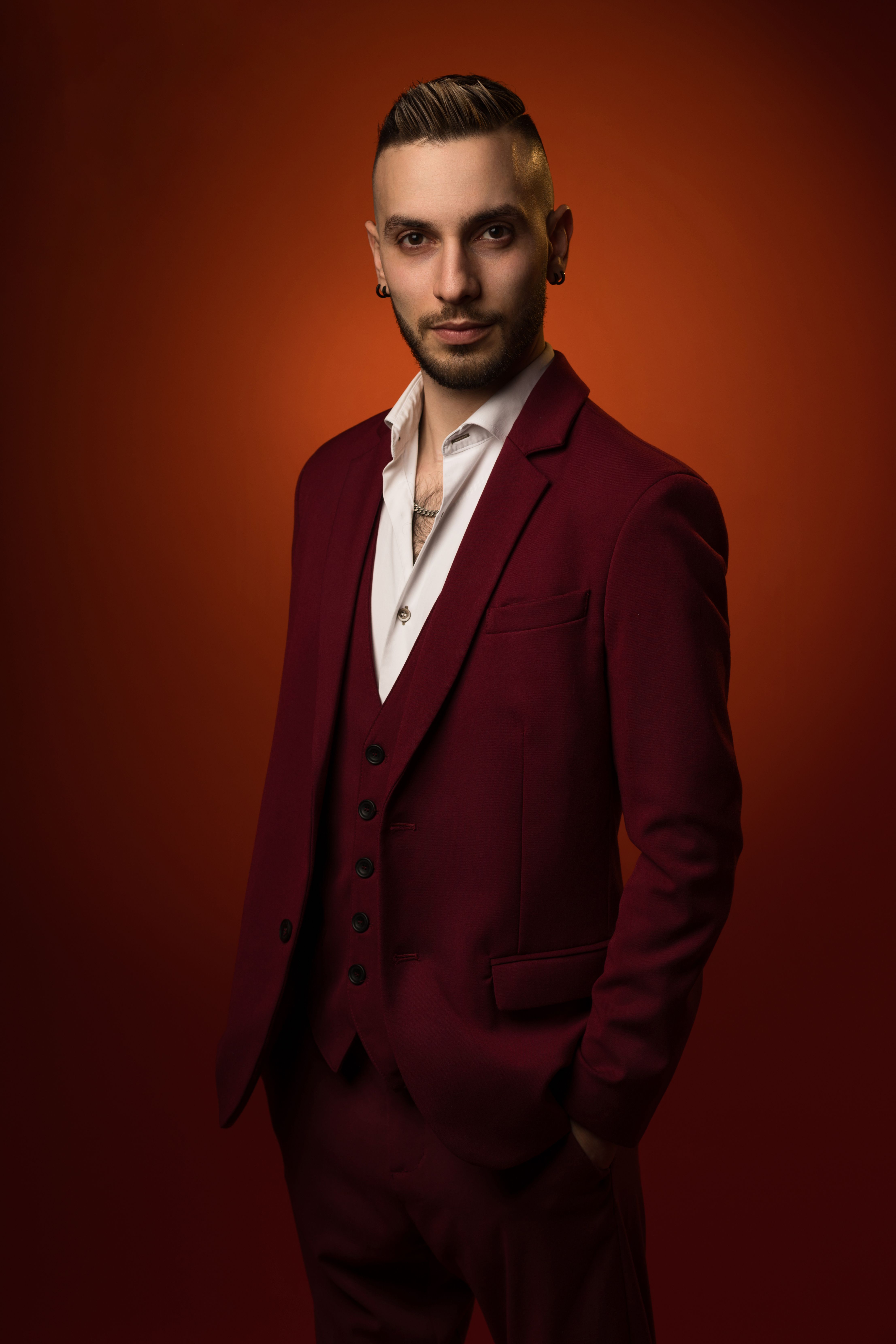 Stylish Man in Burgundy Suit with Dramatic Lighting · Free Stock Photo