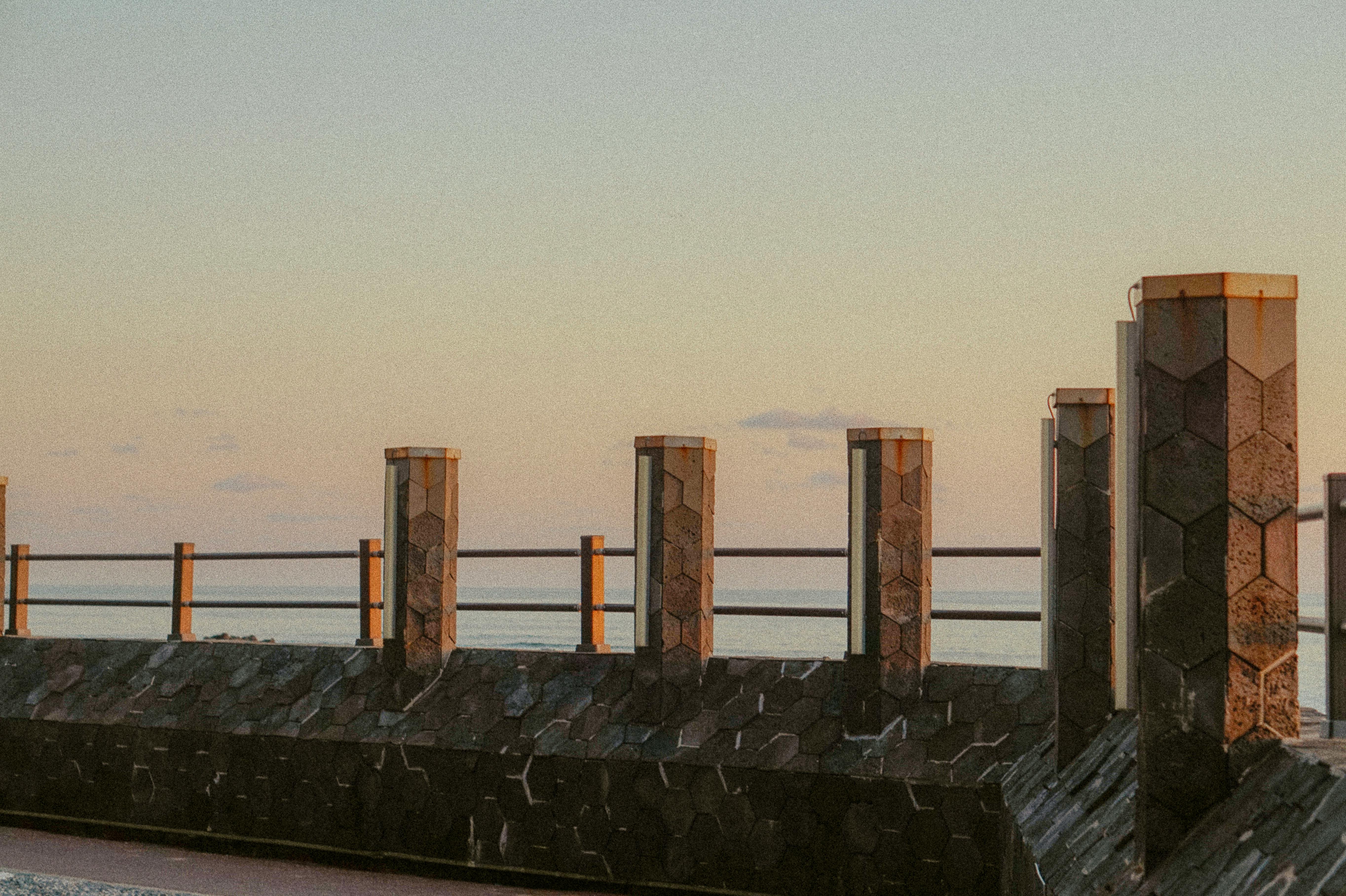 Coastal Promenade at Sunset with Hexagonal Posts · Free Stock Photo